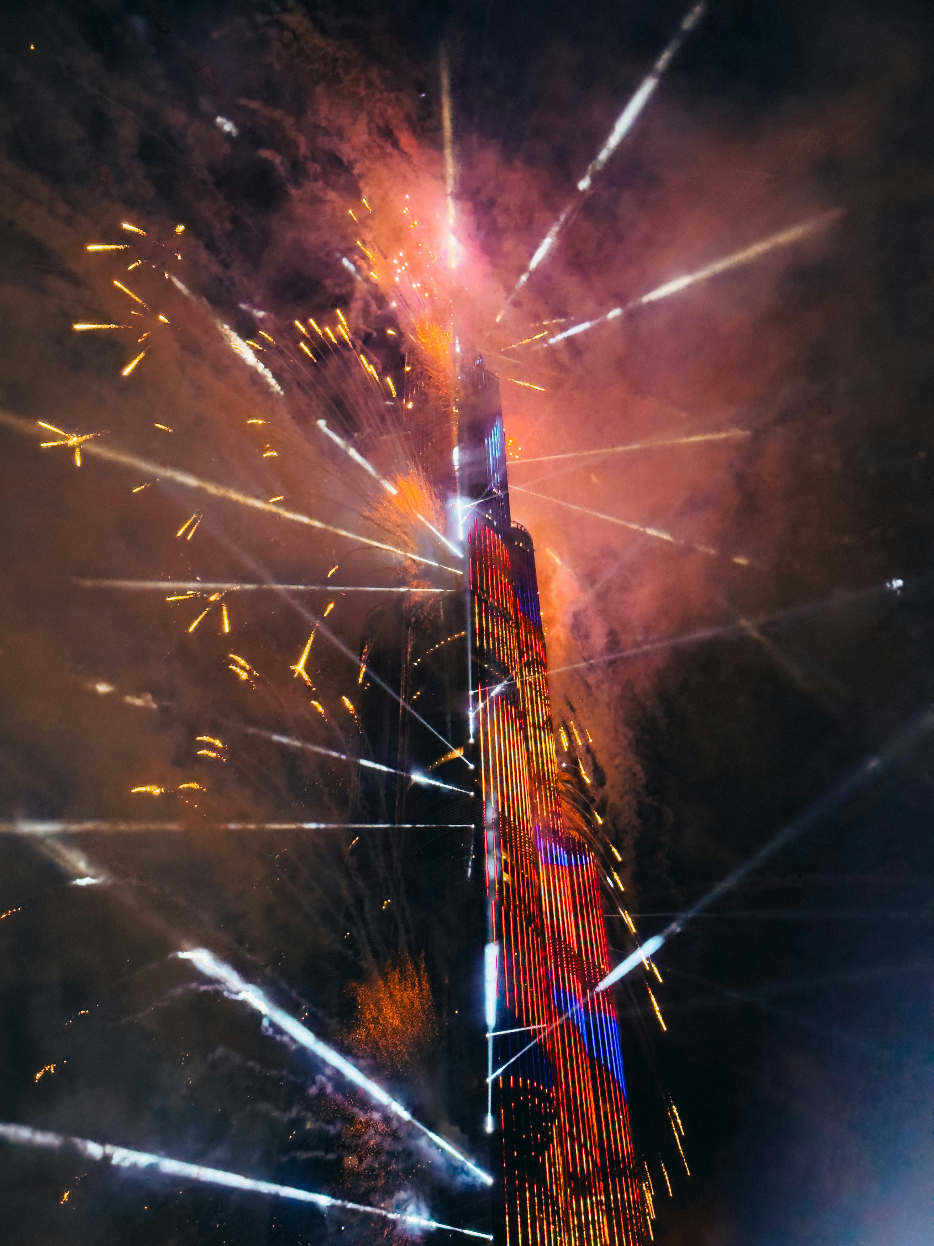 Fireworks are lit up the sky above a tall building photo – Free Dubai ...