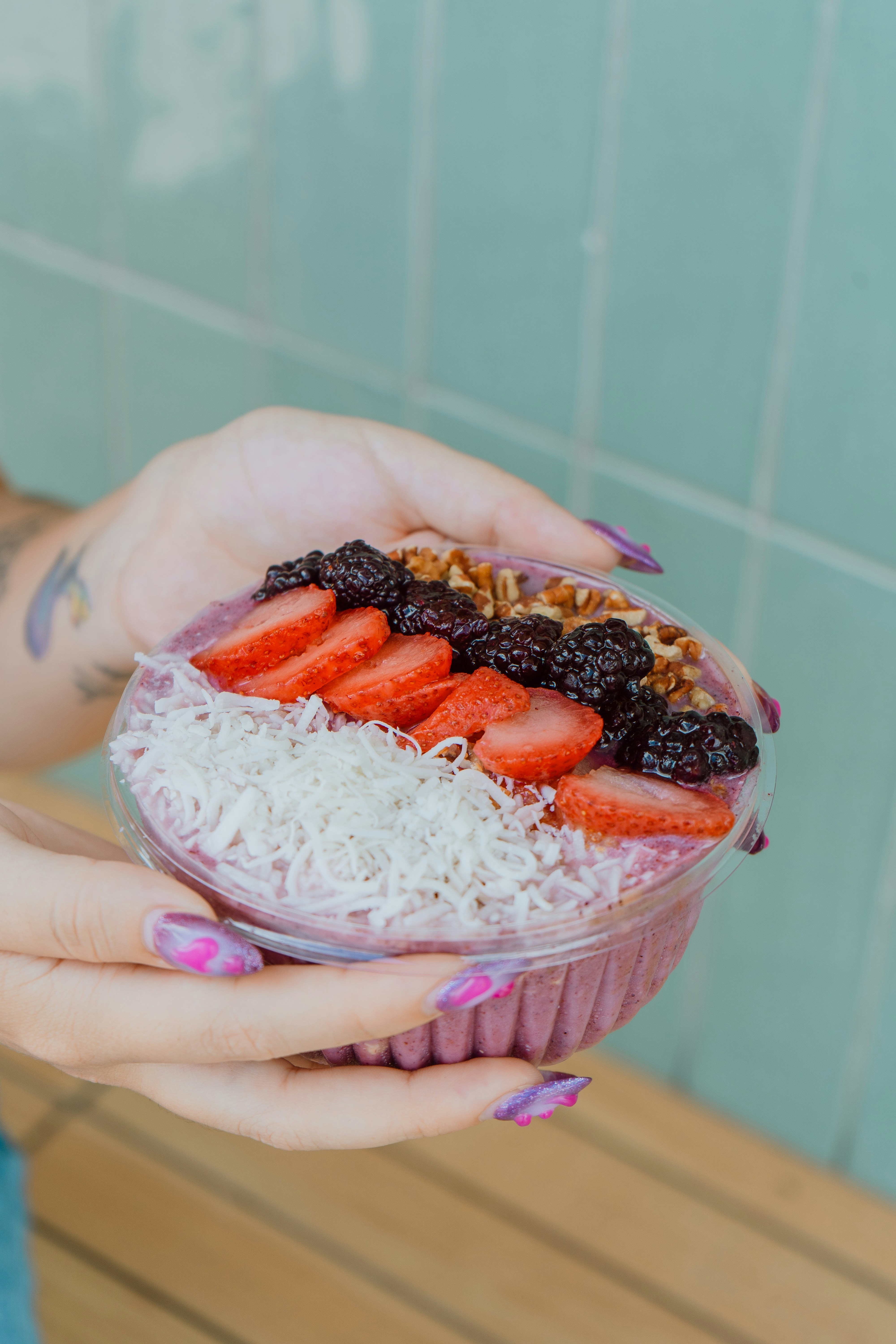 Berry-topped Yogurt Cup Clutched by Painted Nails