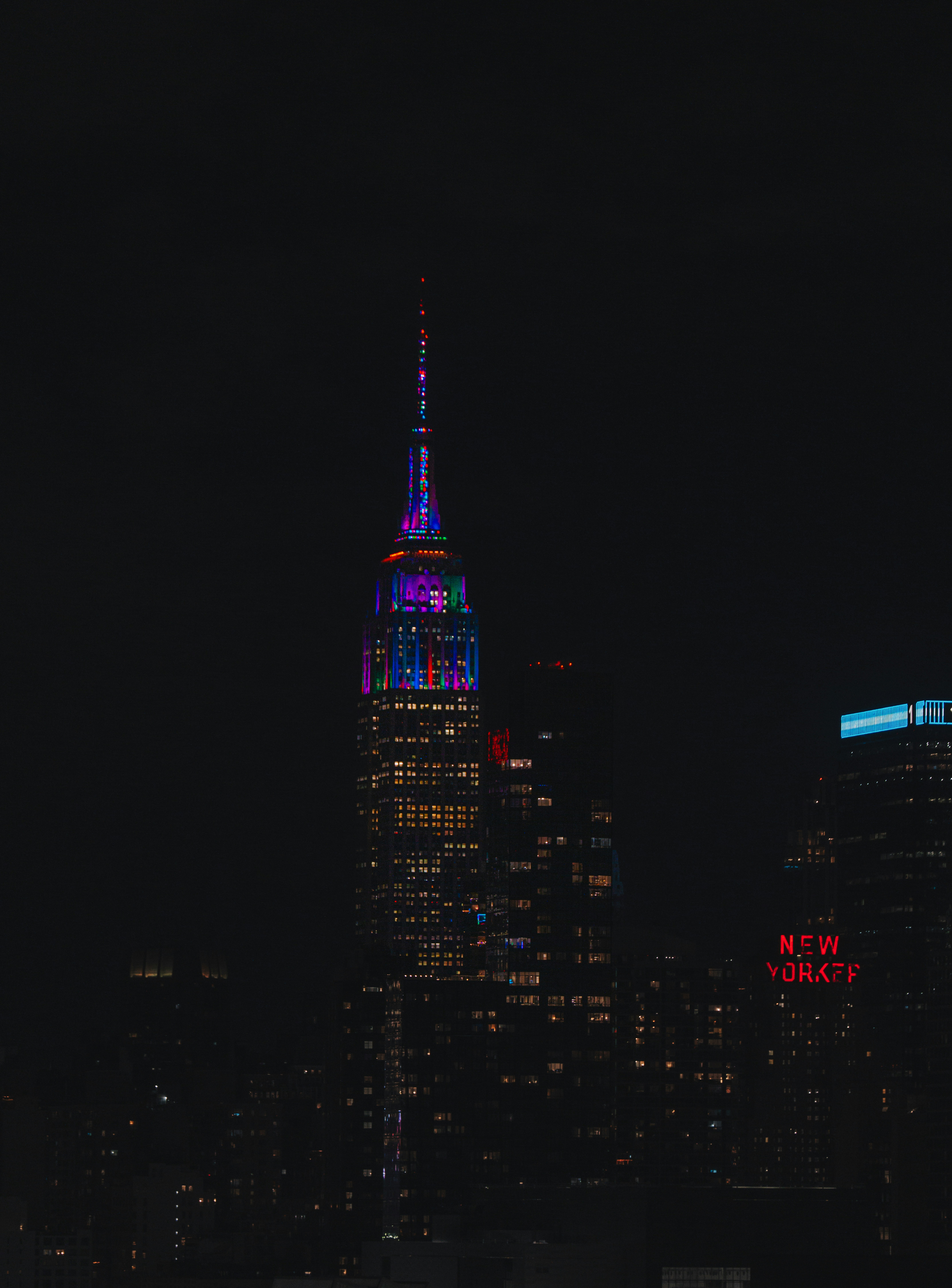 A very tall building lit up at night photo – Free Empire state building ...