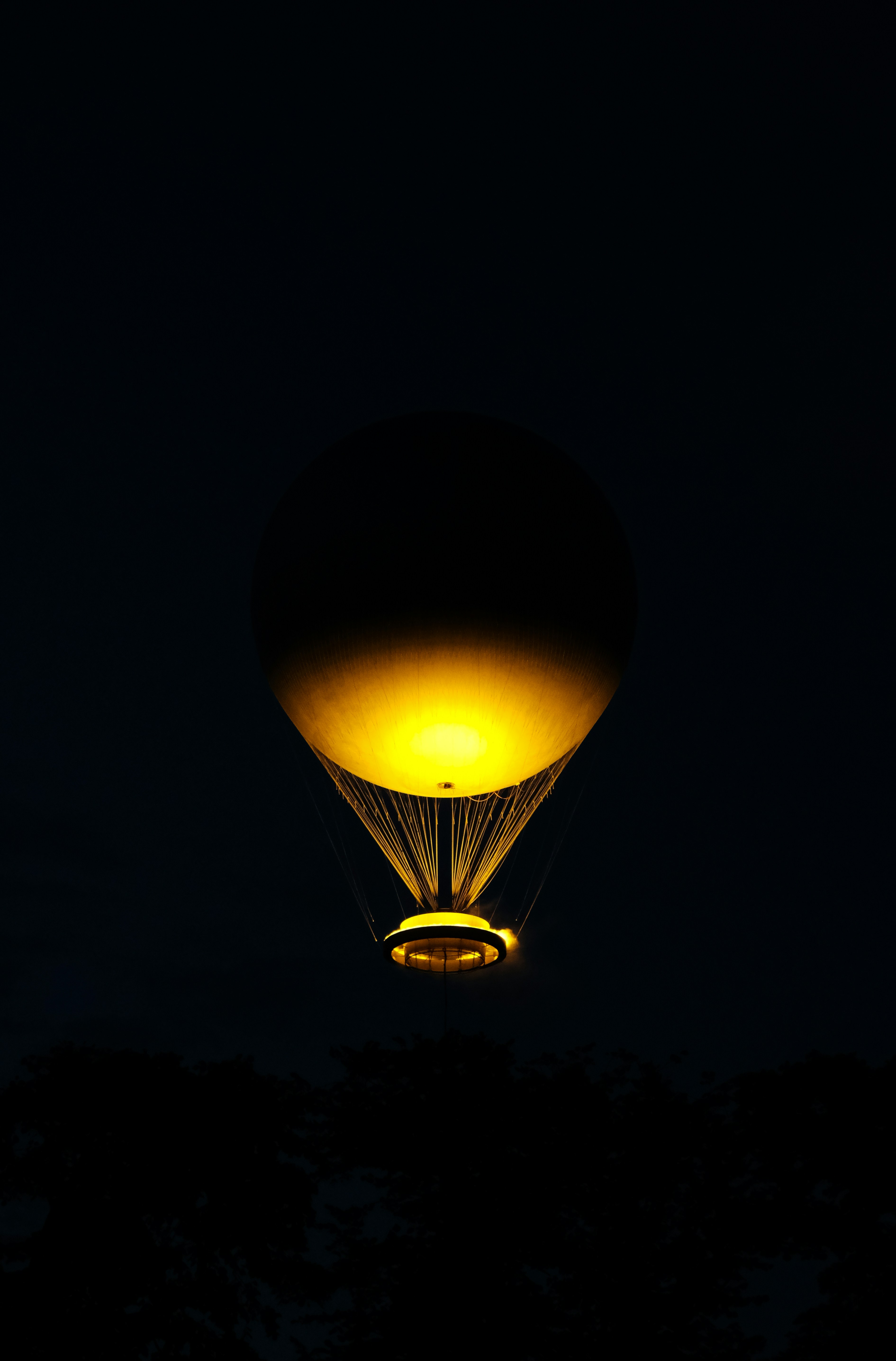 A lit up hot air balloon in the night sky photo – Free Tuileries garden ...