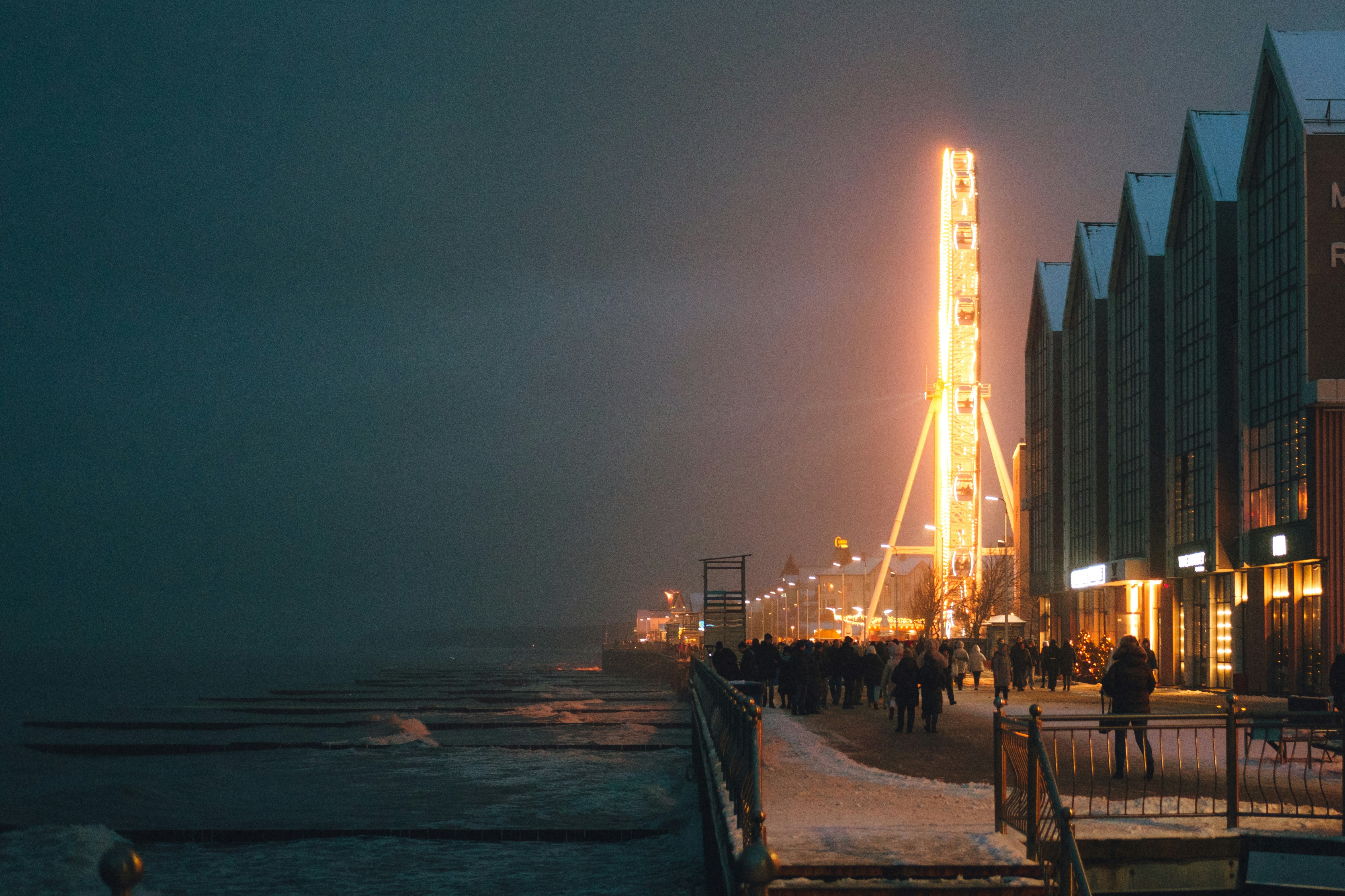 A tall tower sitting on top of a beach next to the ocean photo – Free ...