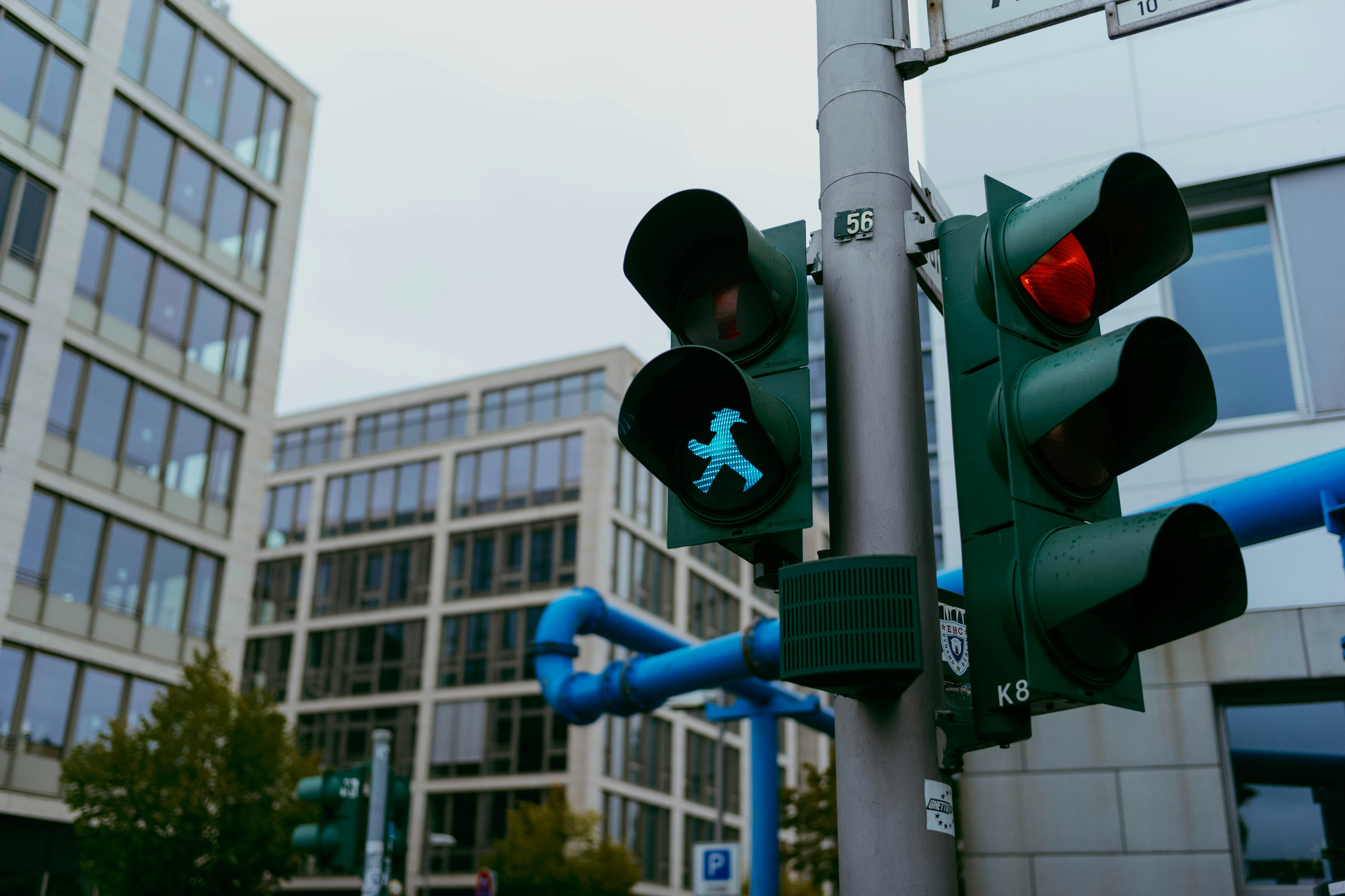 A traffic light sitting next to a tall building photo – Free Light ...