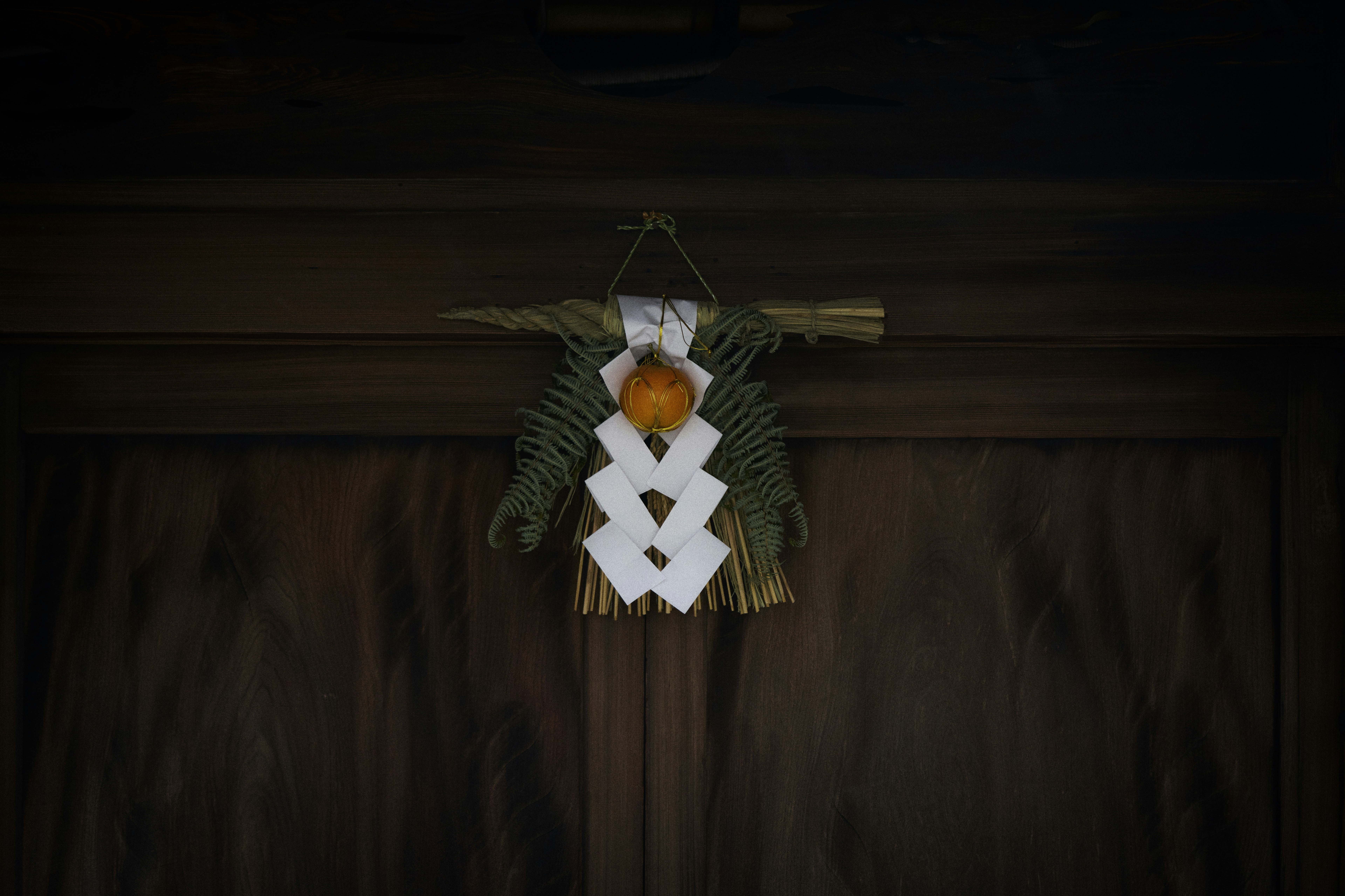 Shimenawa at Dusk: A Quiet Sacred Knot on a Weathered Door