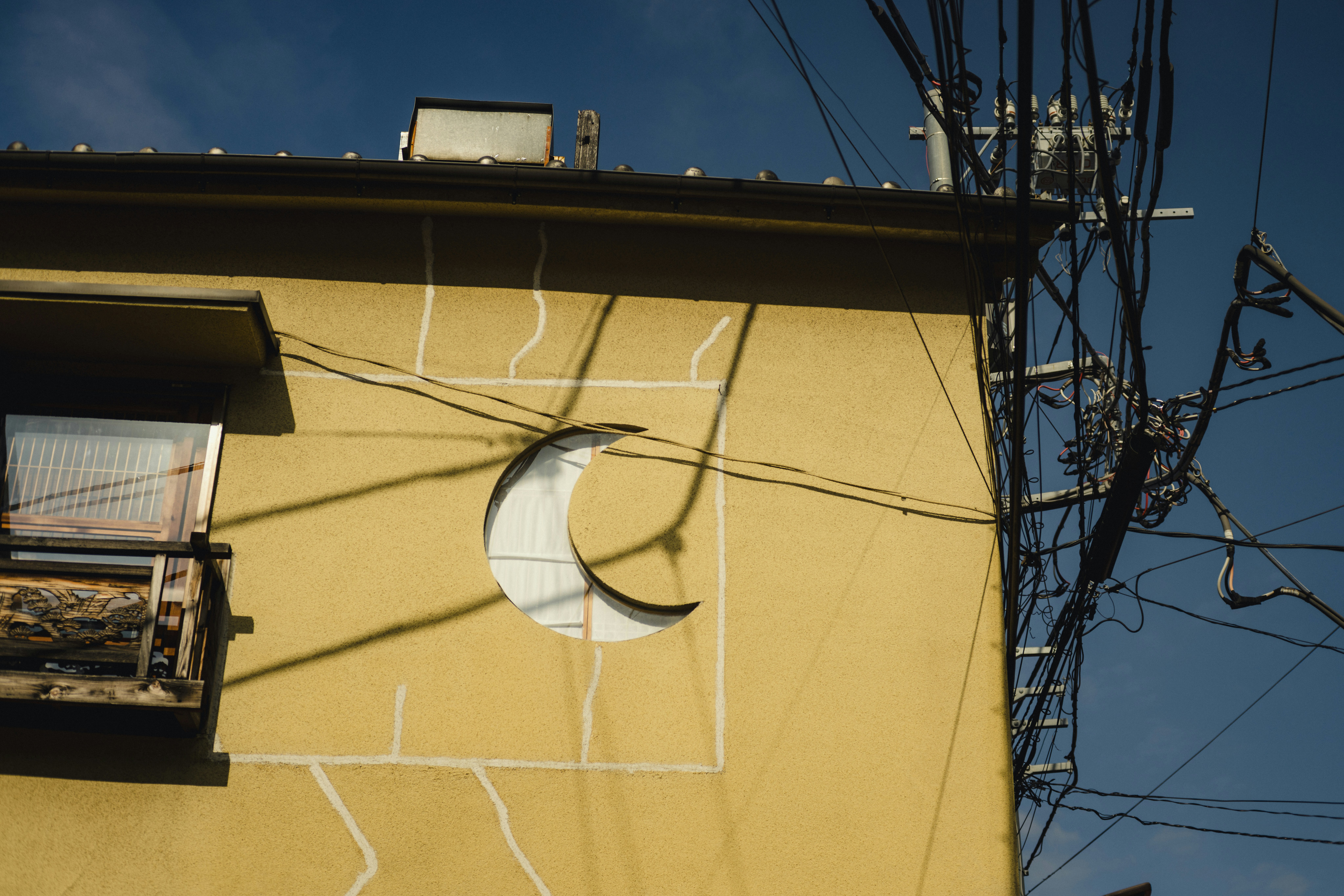 A yellow building with a crescent painted on it photo – Free City Image ...