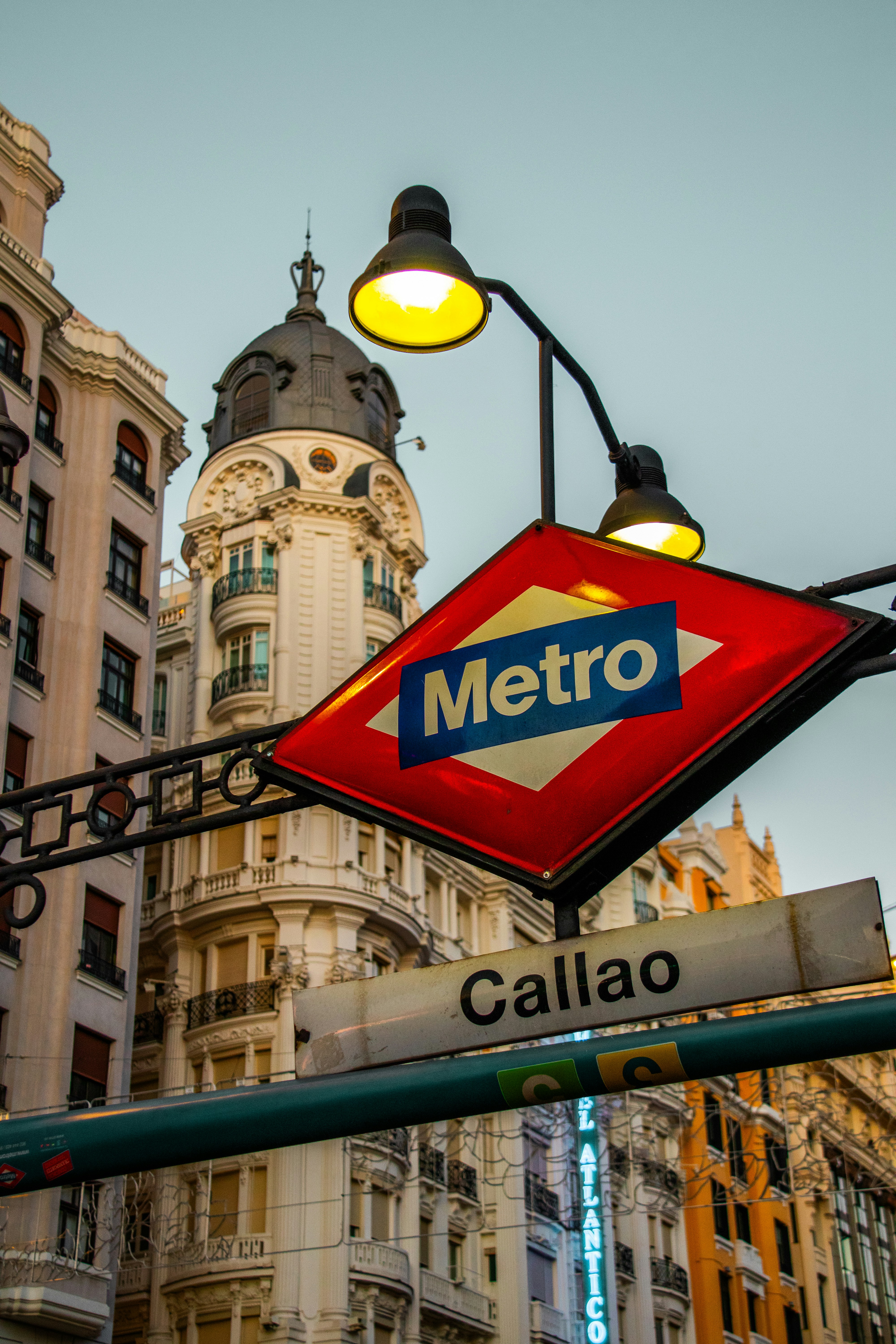 A metro sign hanging off the side of a building photo – Free City Image ...