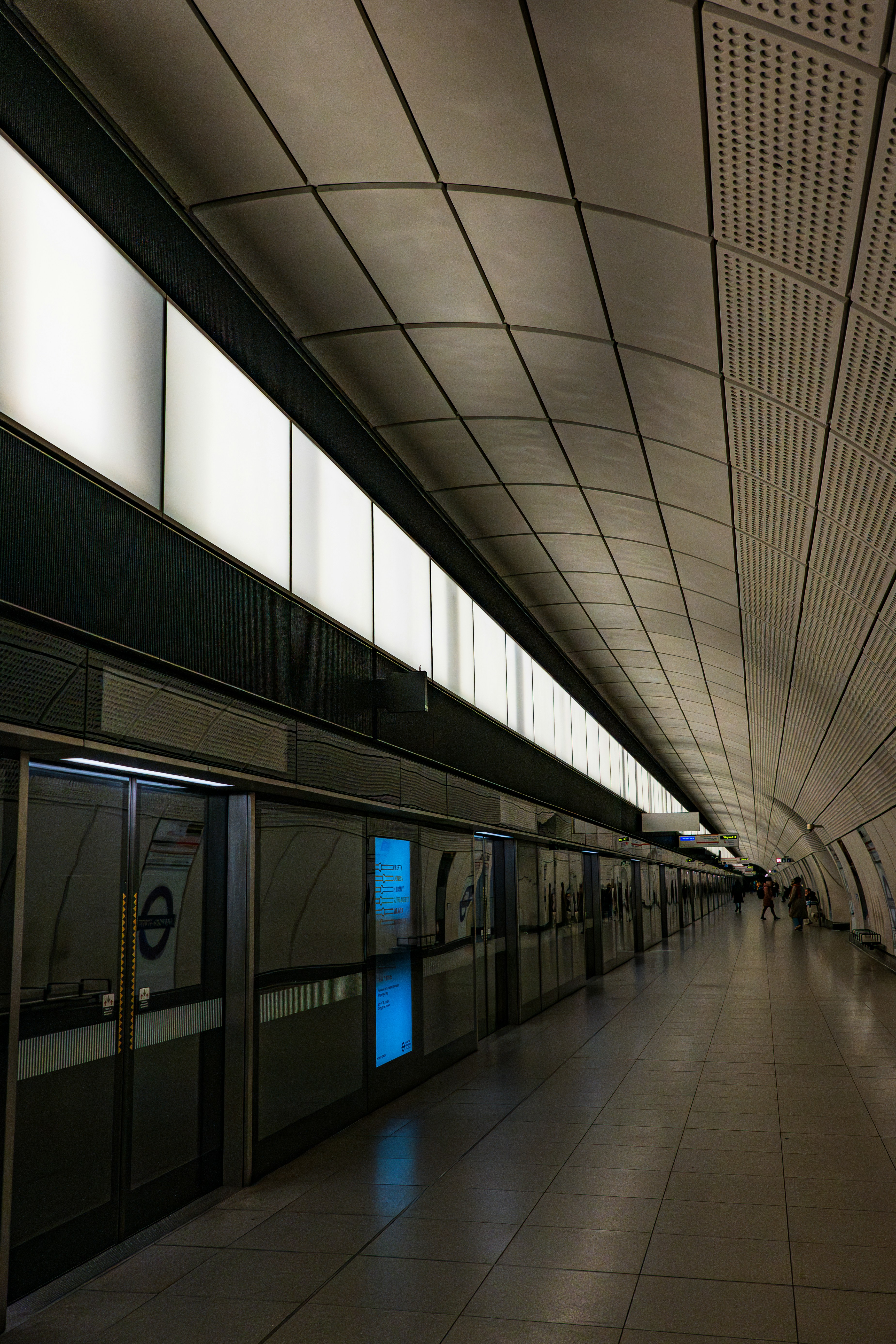 Vanishing Spine of the Subway: A Curved Corridor Toward the Light