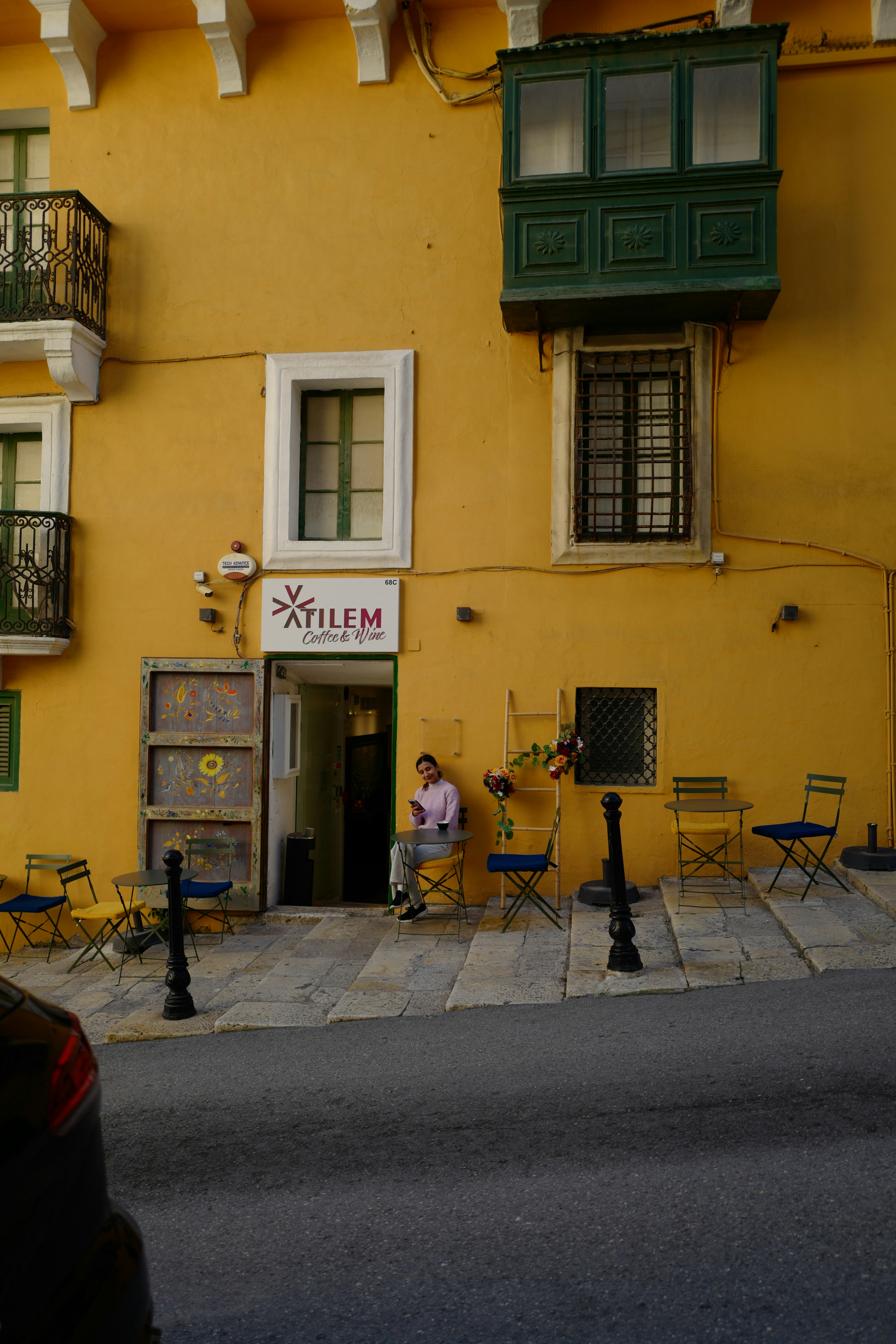 Open-Door Moment: Sunlit Café Façade on a Quiet Street