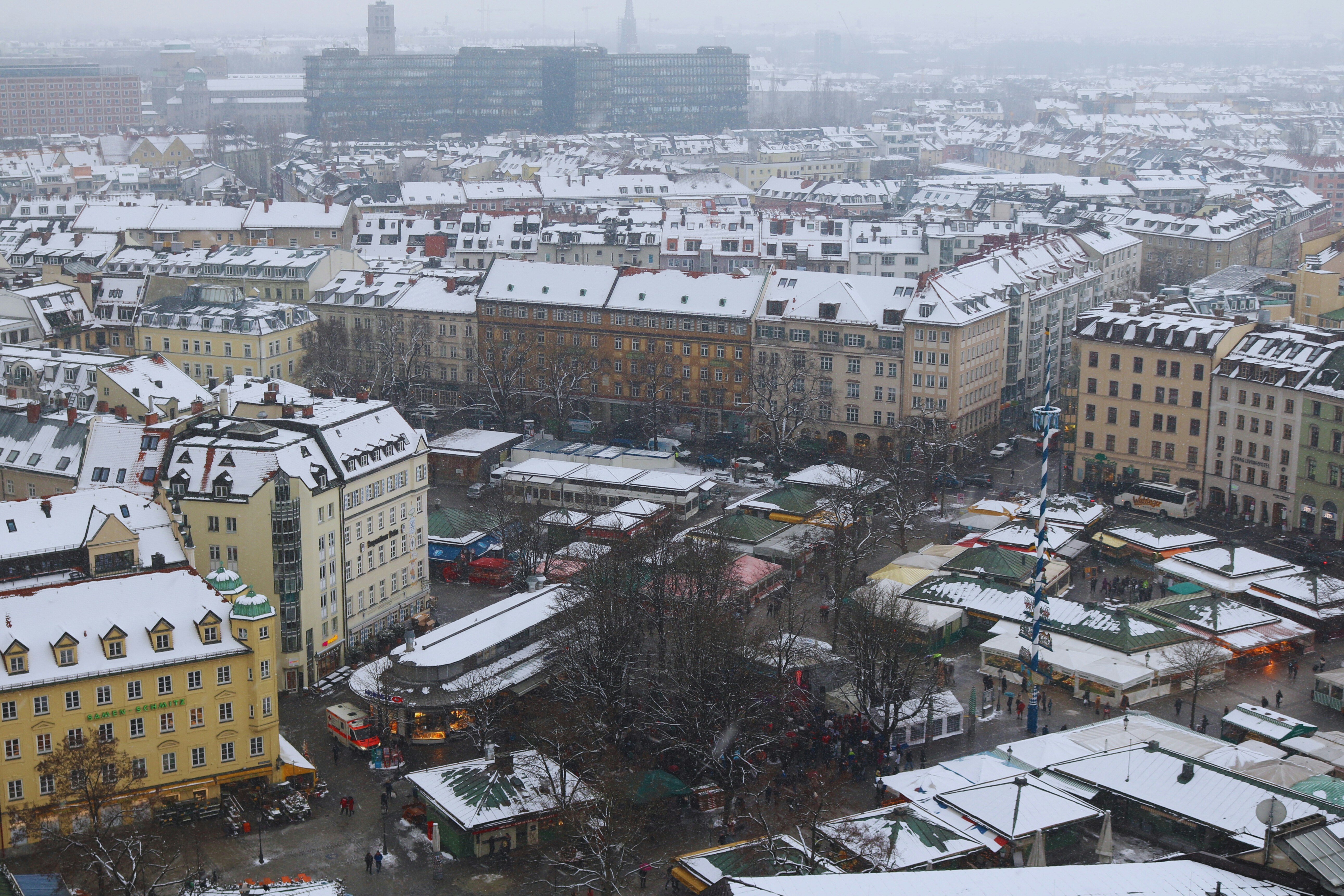 A city with lots of snow covered buildings photo – Free Munich Image on ...