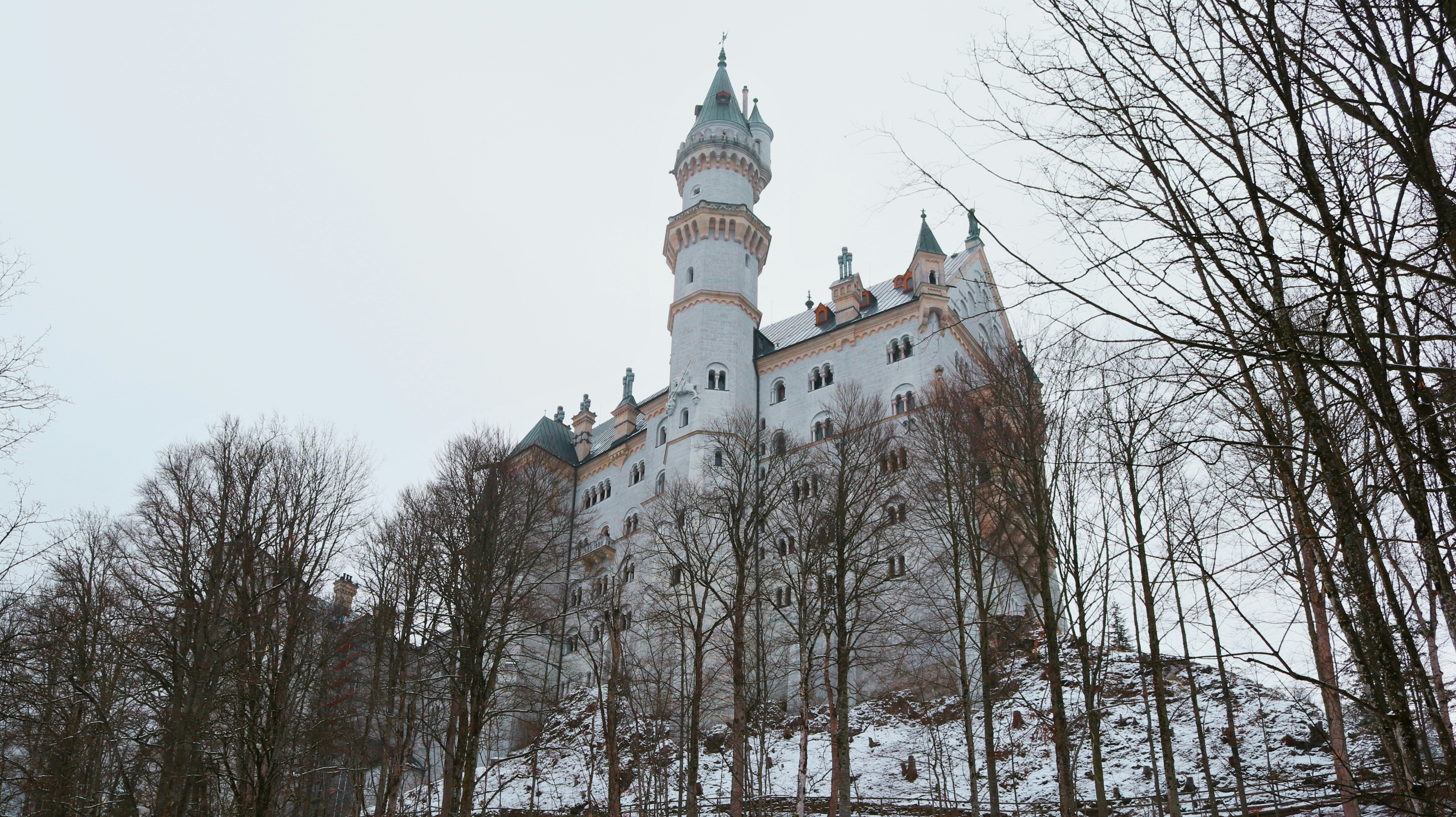 A large white castle with a clock tower photo – Free Neuschwanstein ...