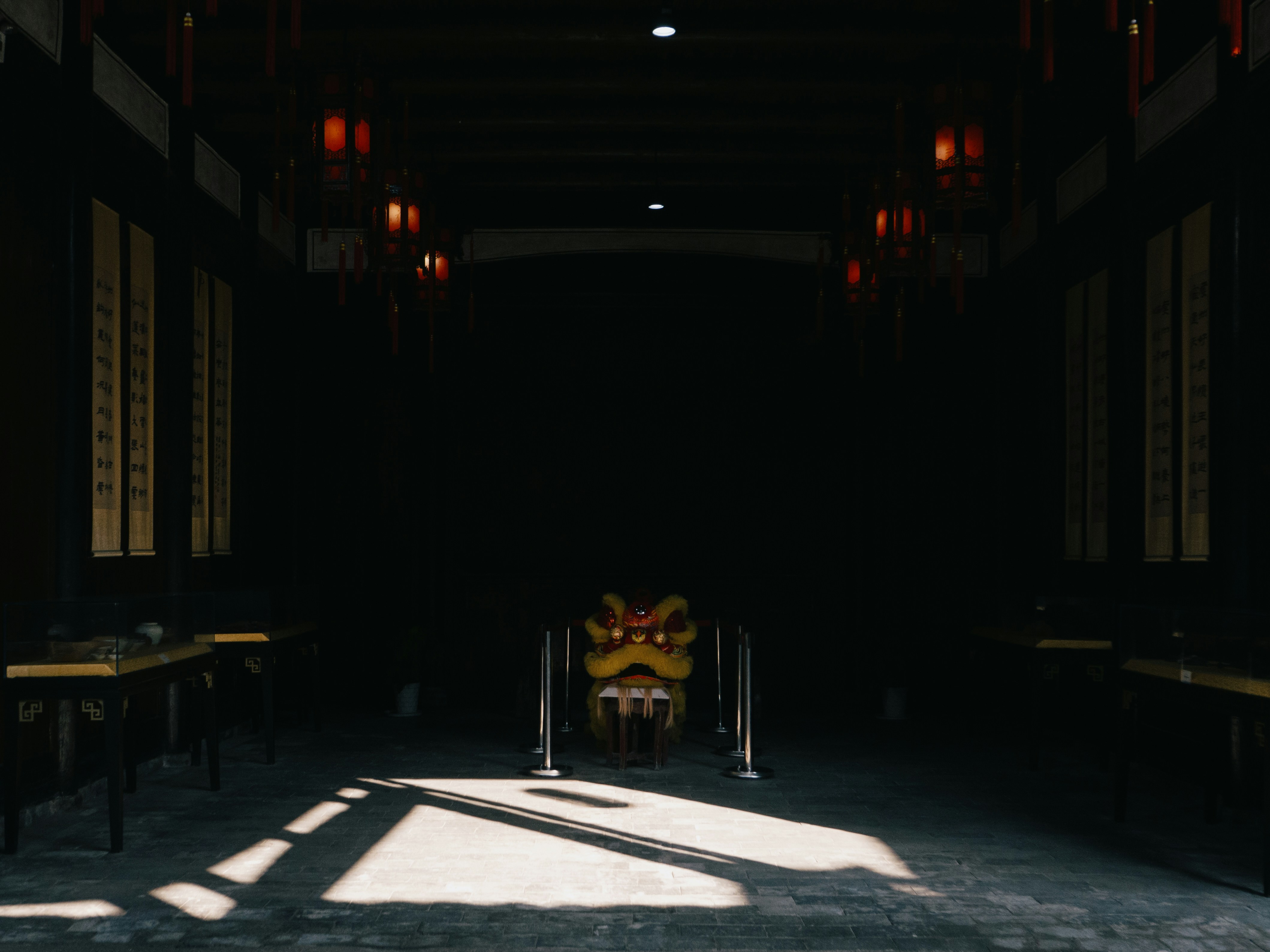 A dimly lit room with benches and tables photo – Free Performer Image ...