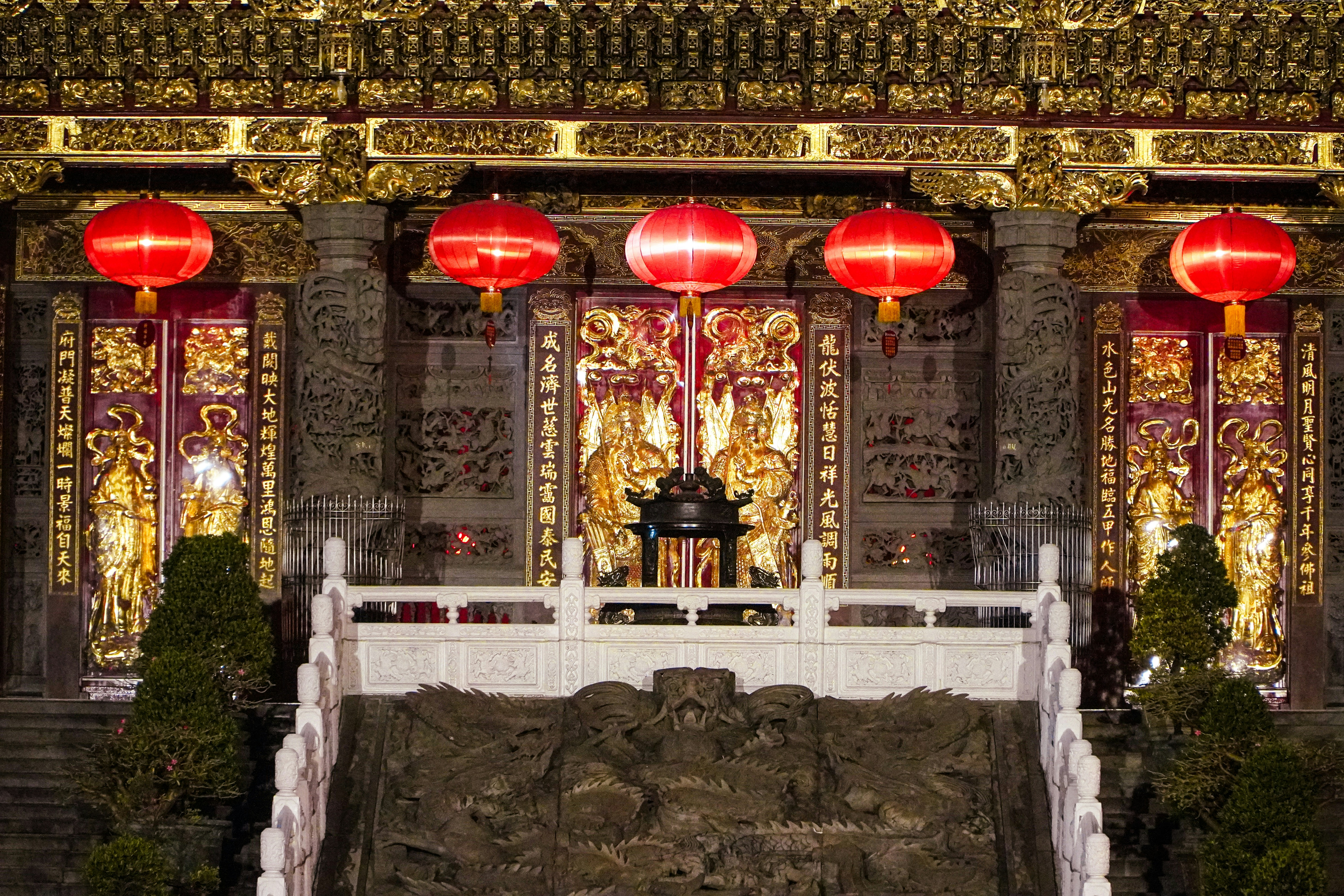 Crimson Lanterns Framing a Golden Altar in an Ornate Temple Hall