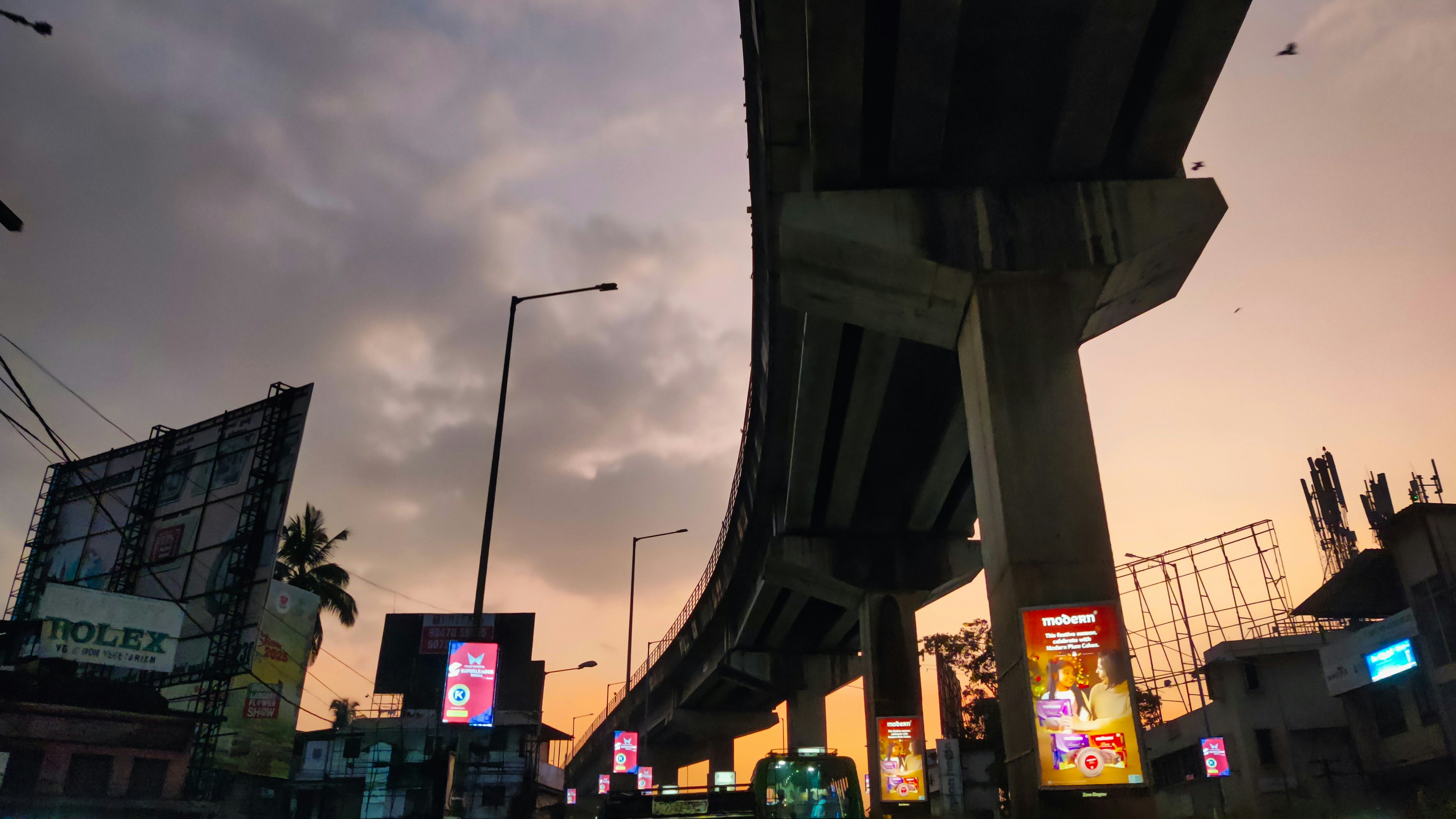 Sunset Under the City's Spine: Urban Pulse Beneath the Flyover