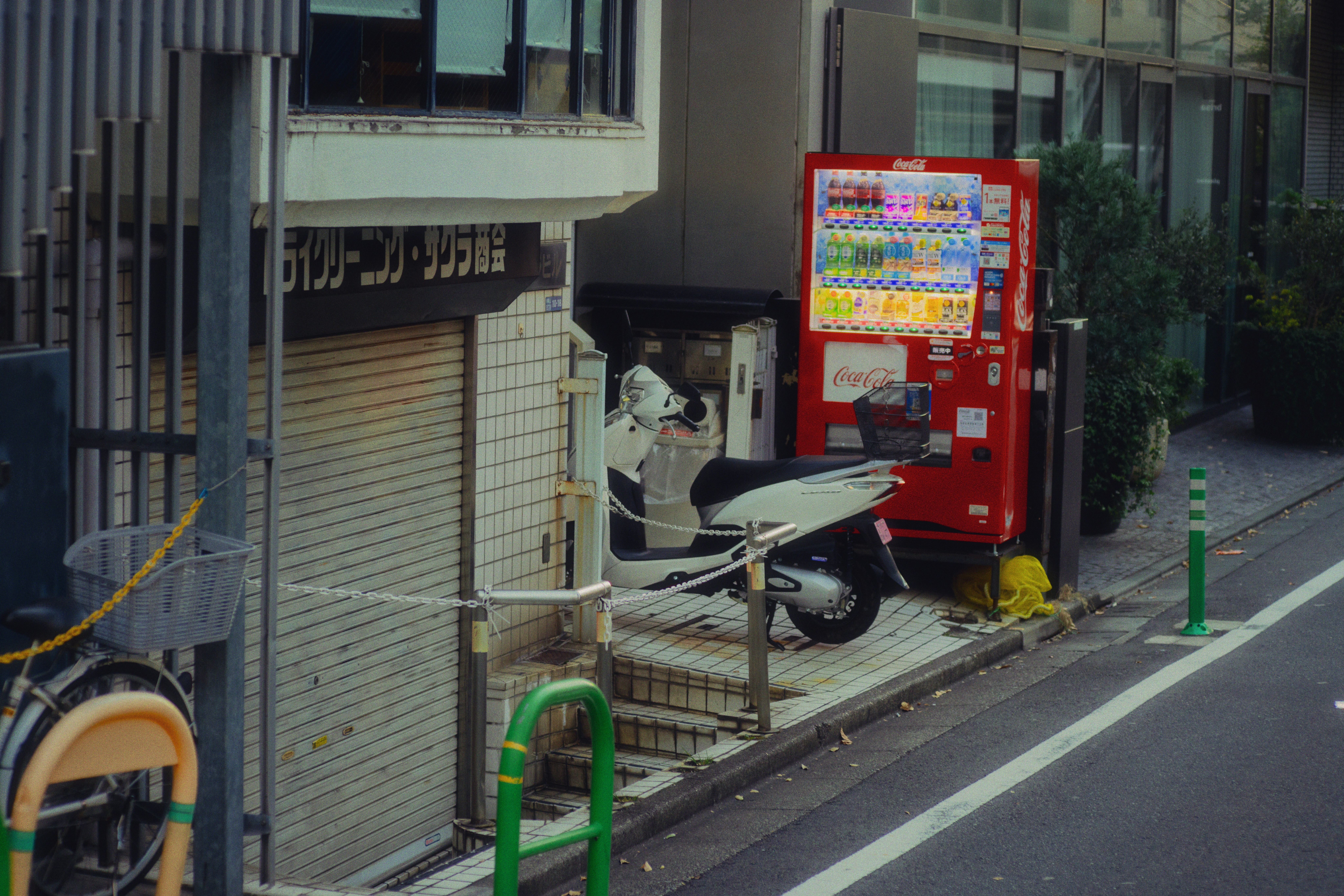 A red vending machine sitting on the side of a street photo – Free ...