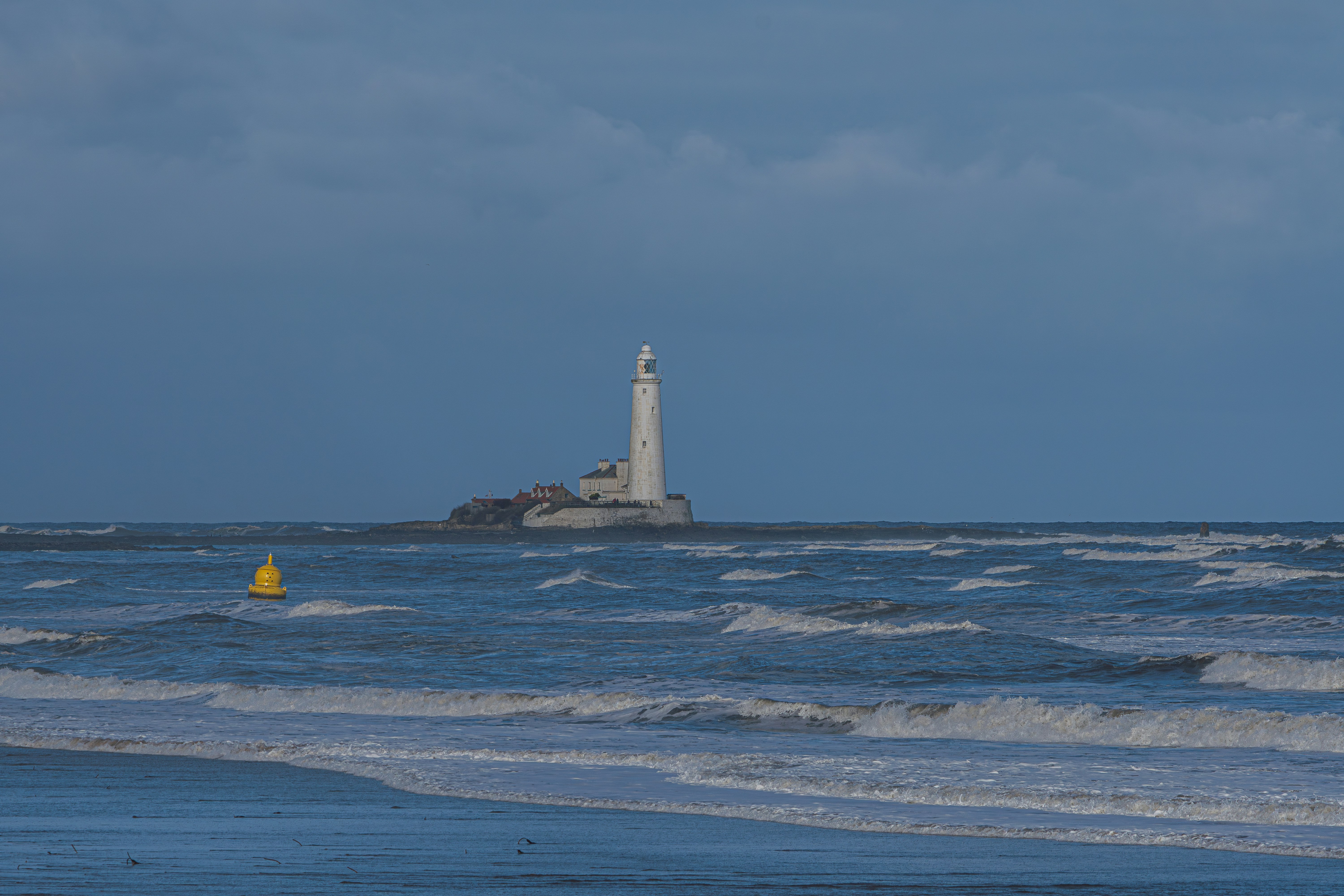 A lighthouse in the middle of a body of water photo – Free Lighthouse ...