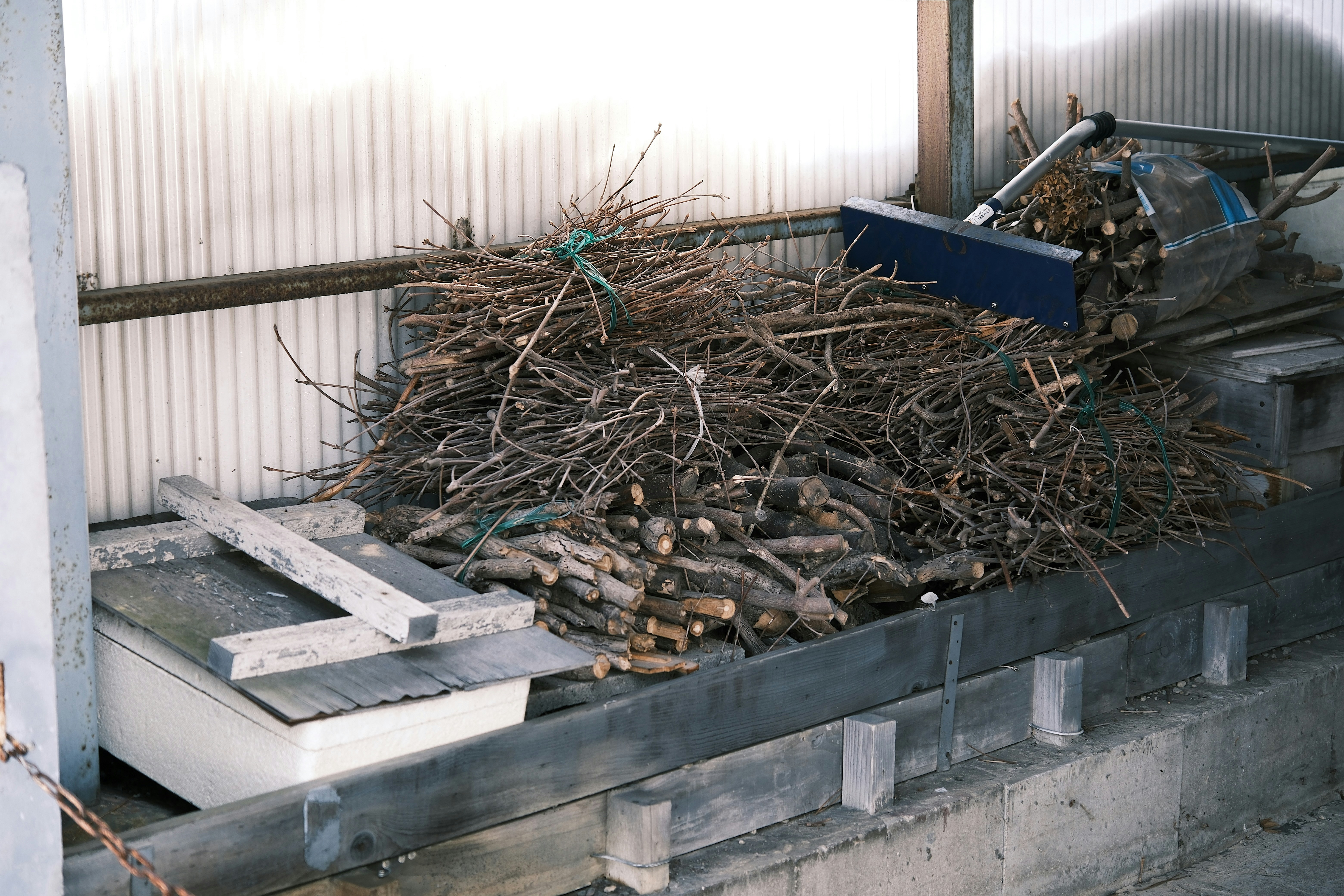 Bundles of Twigs and Firewood in an Industrial Corner