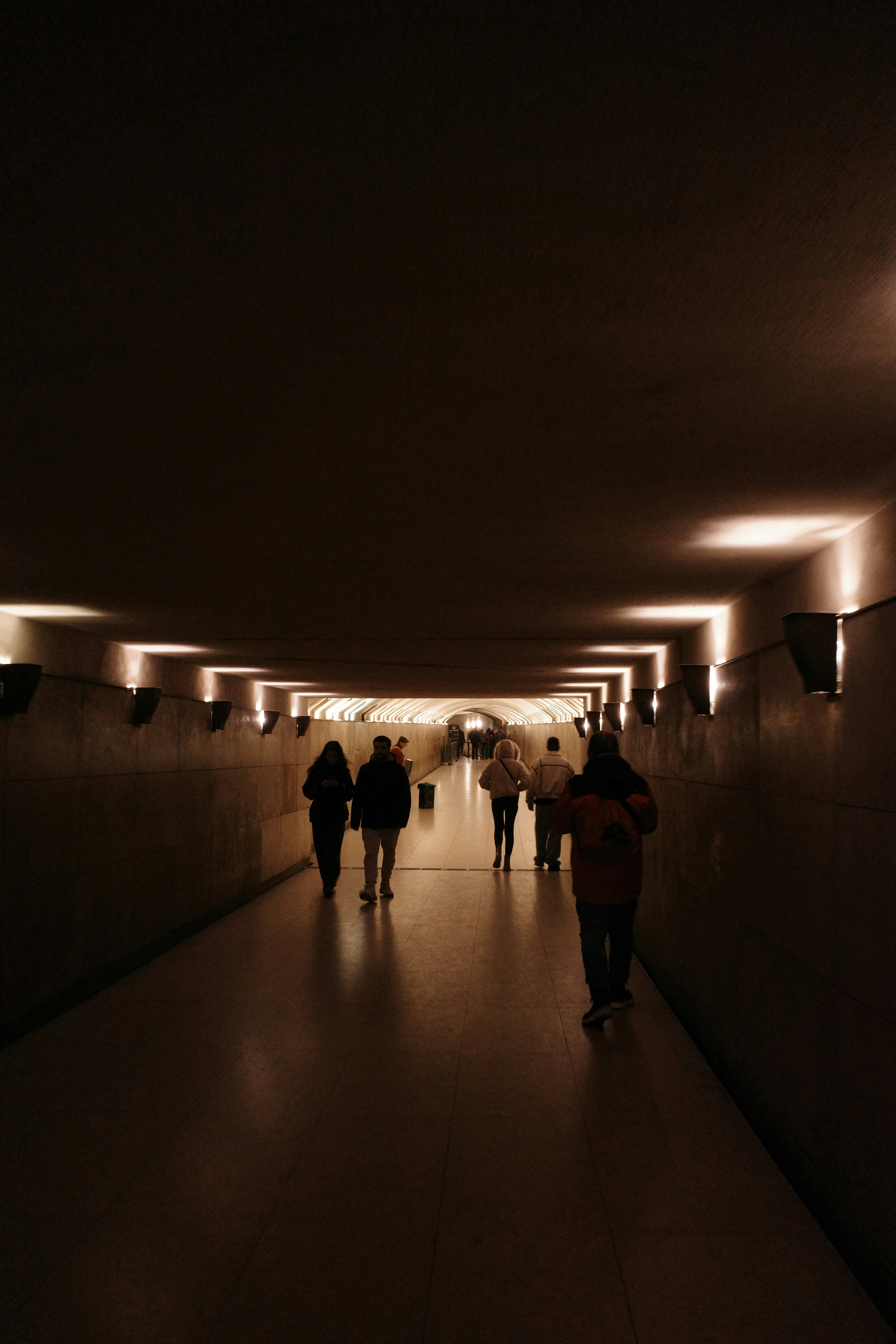 A group of people walking down a long hallway photo – Free Street ...