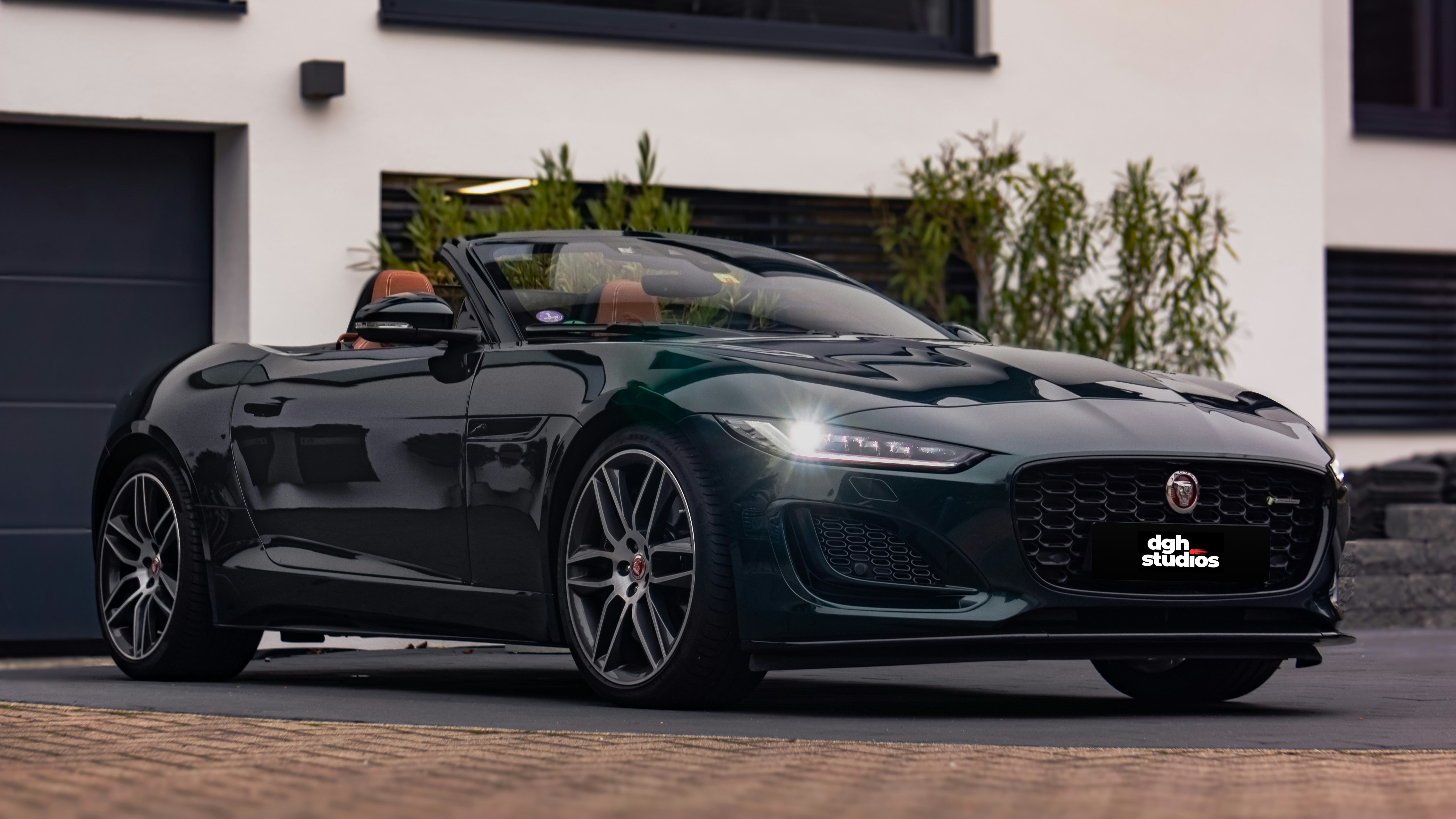 Midnight-Green Jaguar F-Type Convertible in a Quiet Courtyard