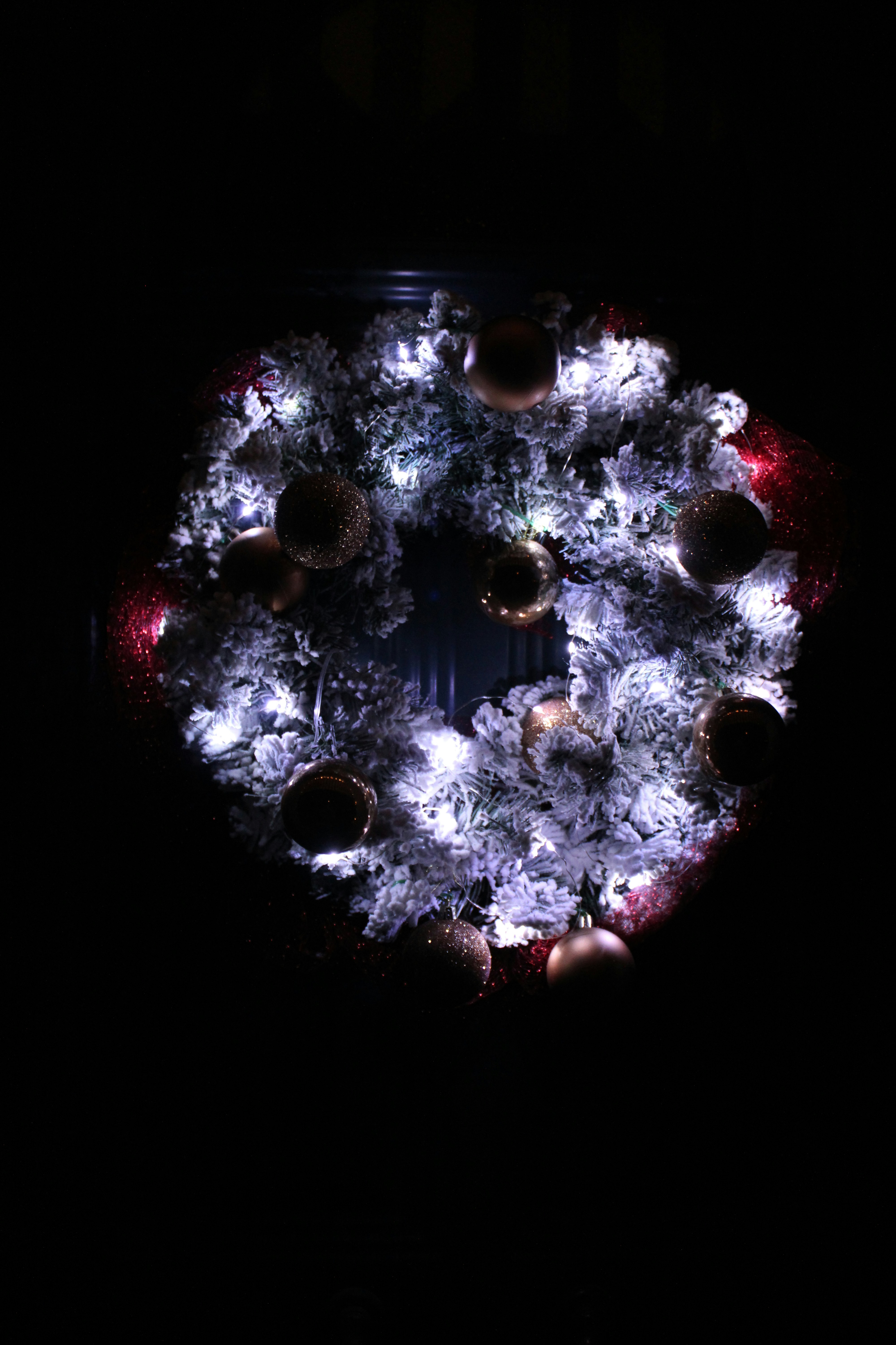 Midnight Halo: Frosted Christmas Wreath in a Quiet Ring of Light