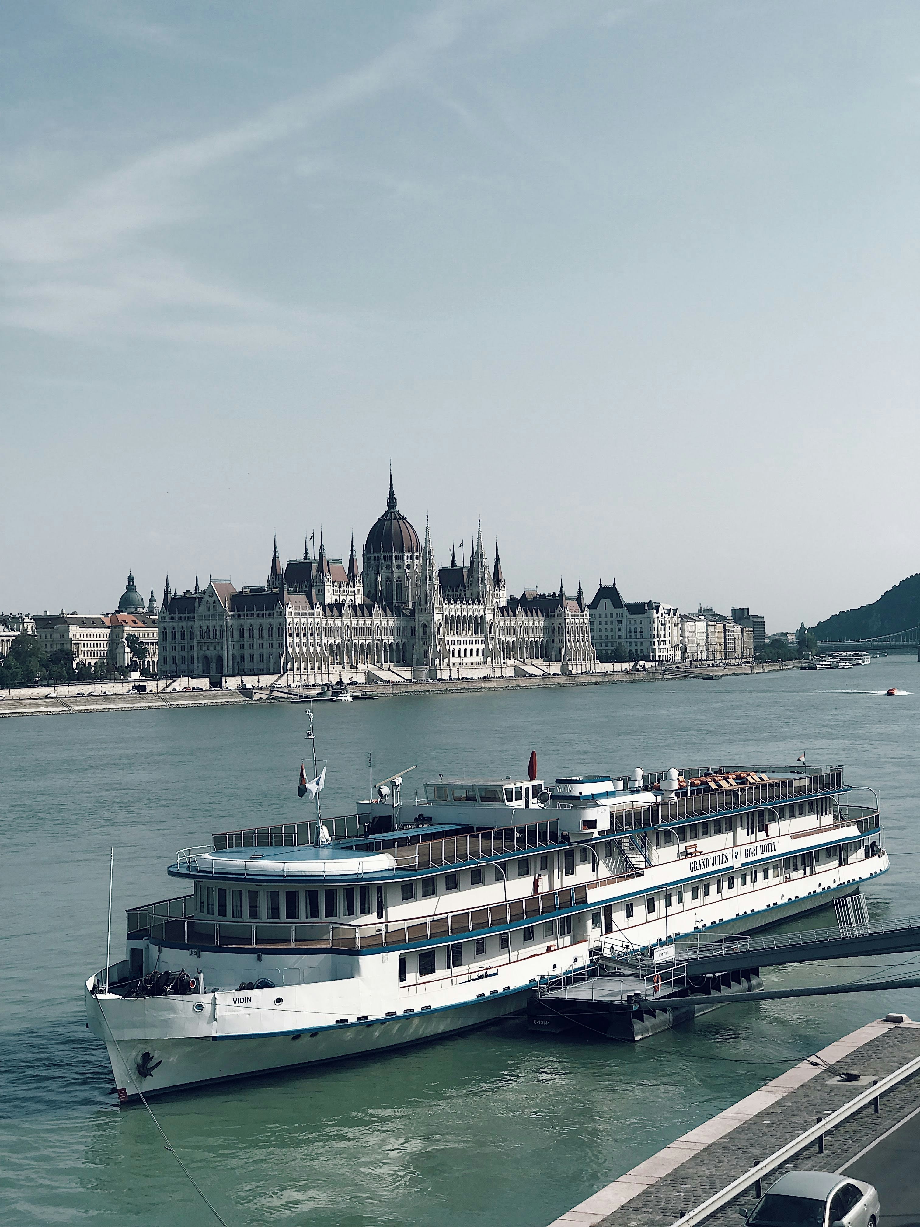 Harbor Parade: A Budapest Riverfront Scene with a Docked Boat