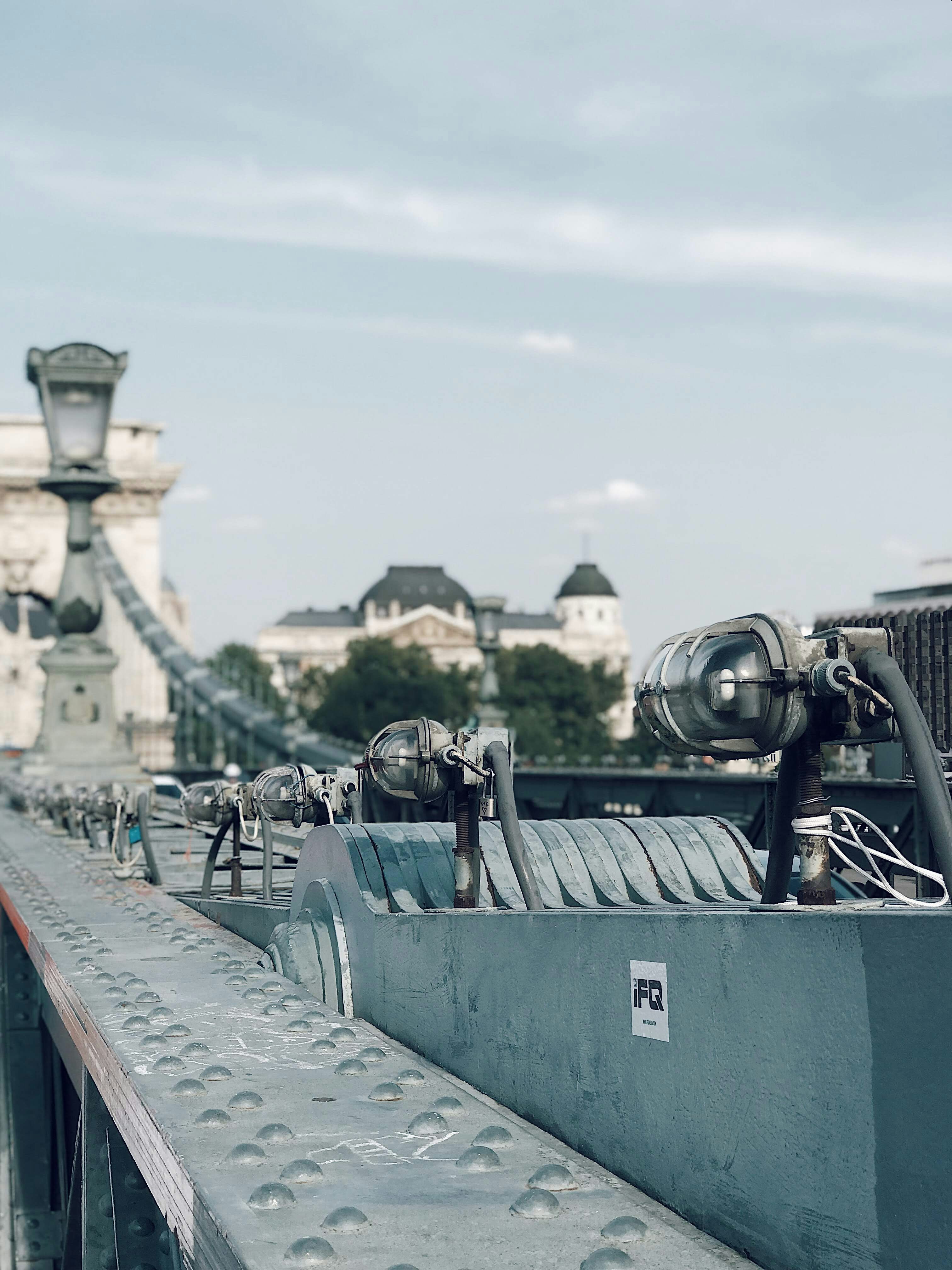 Riveted Horizon: Rails and Lamps Toward a Distant Skyline