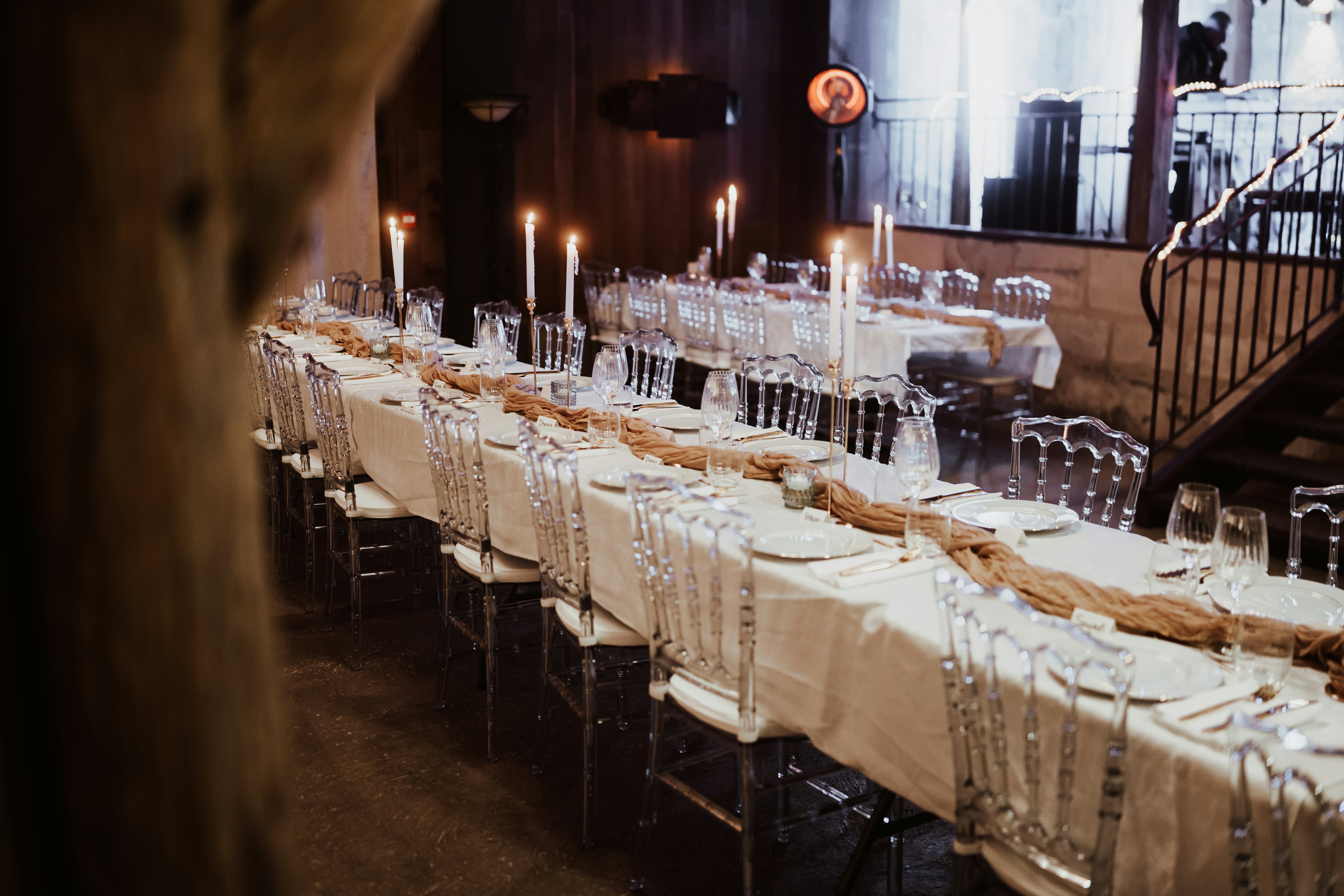 A long table with a lot of white tablecloths