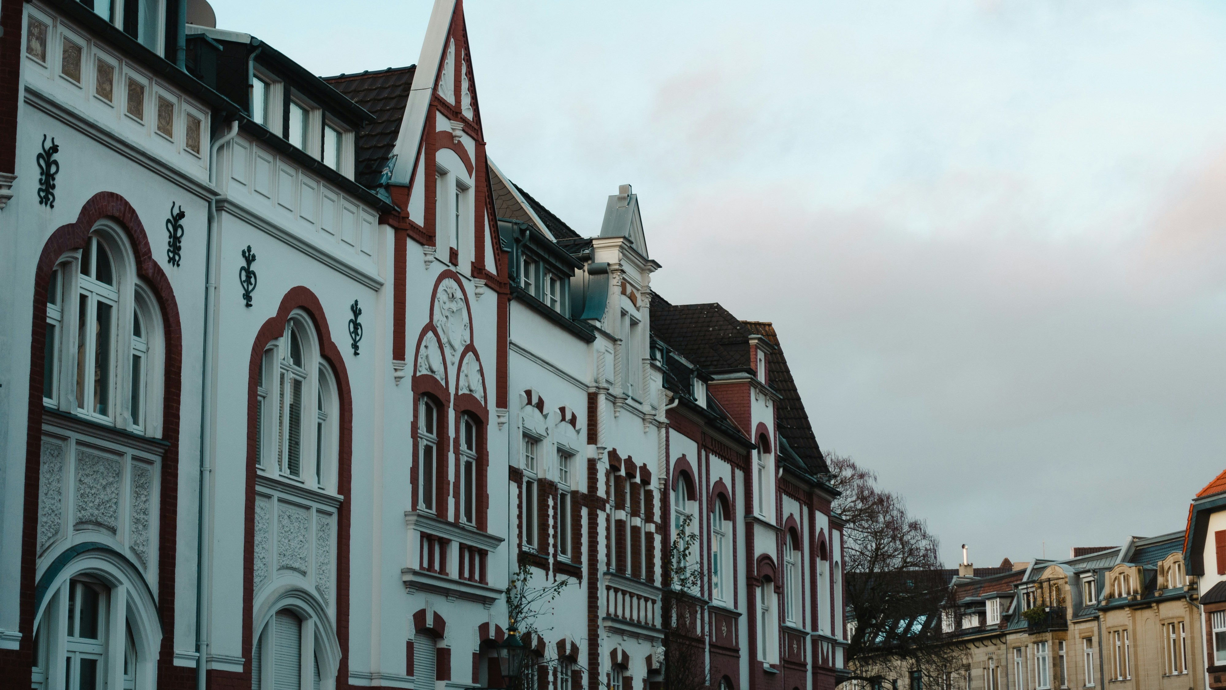 A row of white and red buildings next to each other photo – Free ...