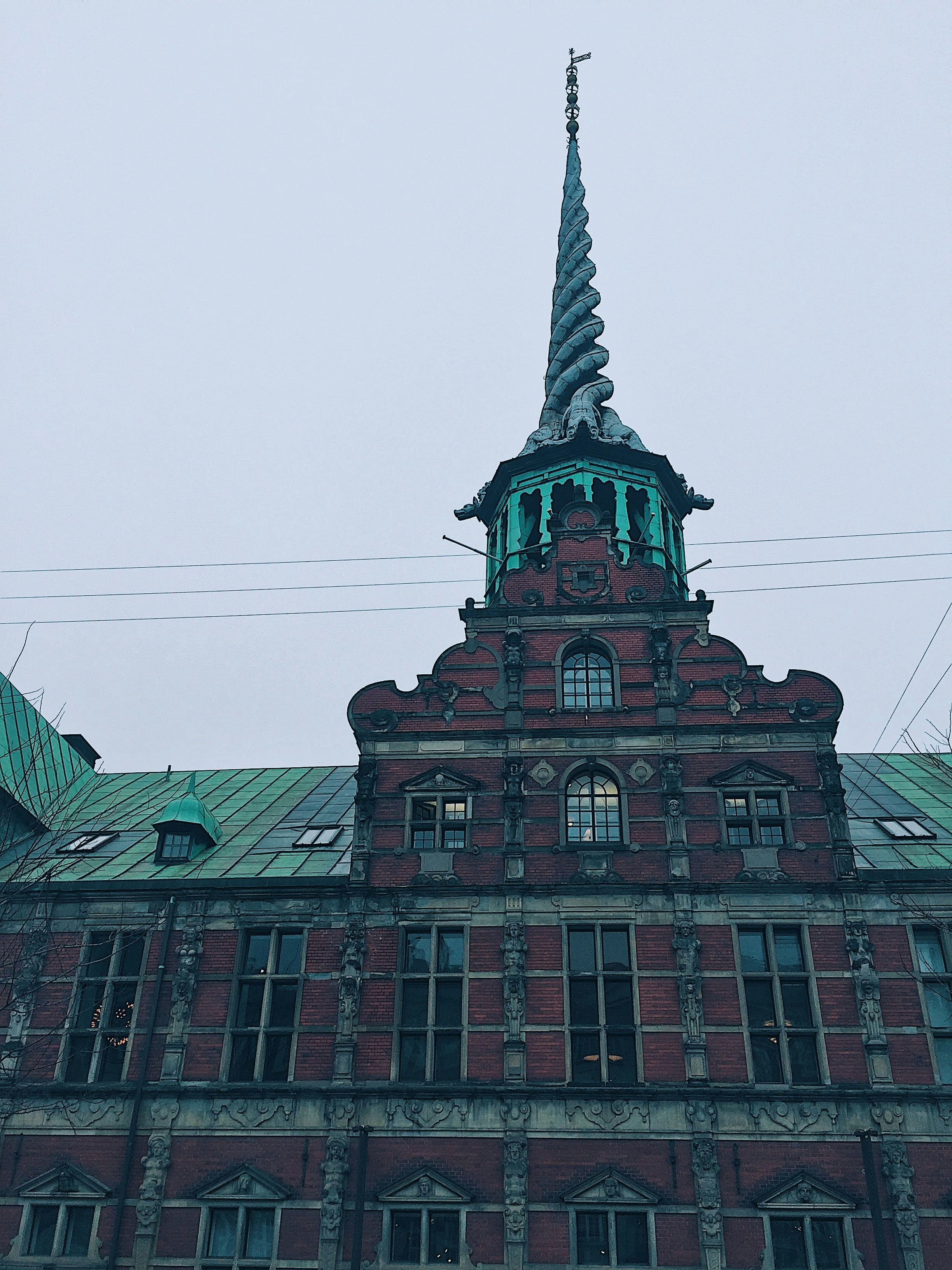 Ornate City Hall Spire Reaches Skyward from Brick Facade