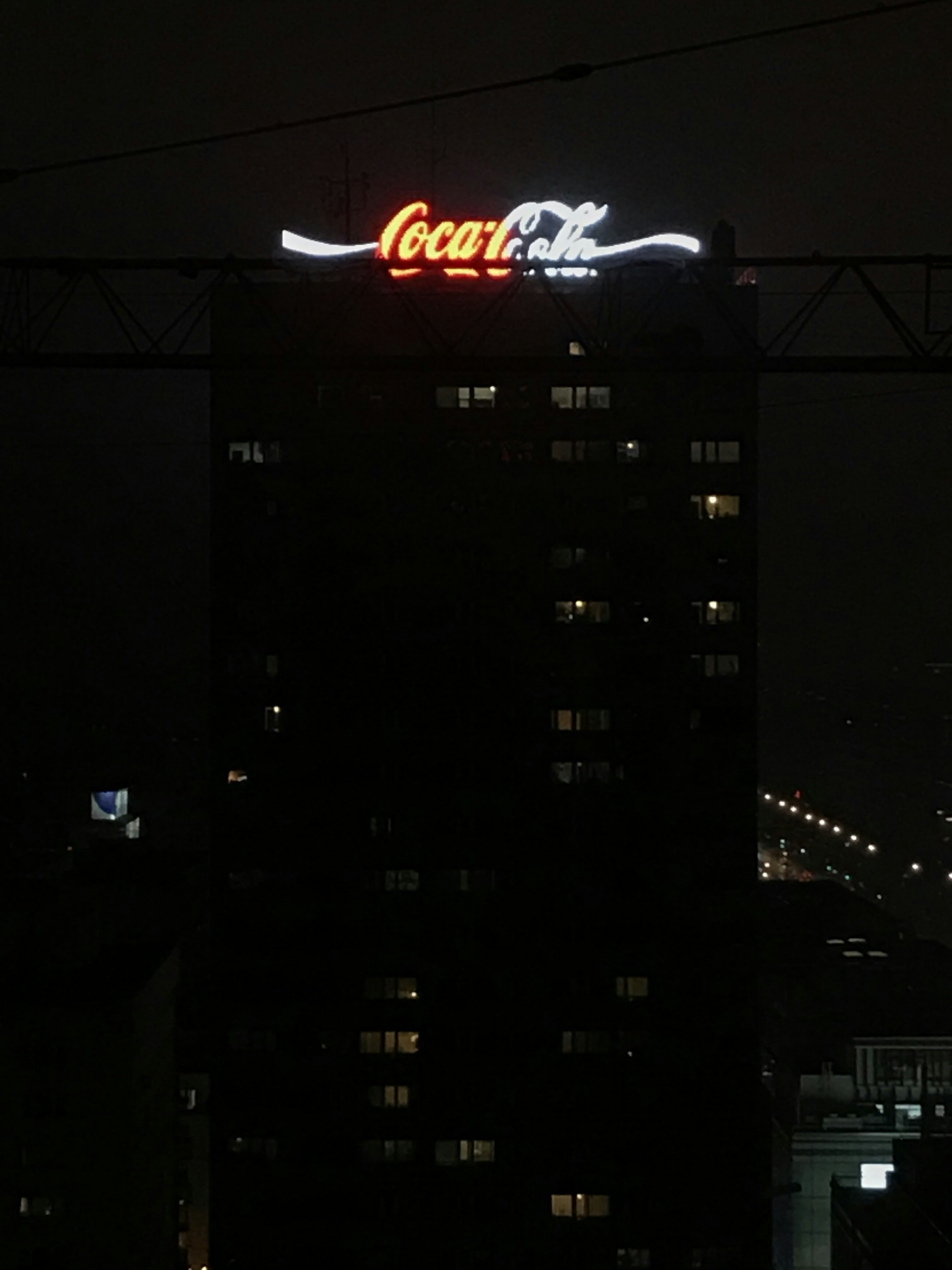 A building with a neon sign on top of it photo – Free Warsaw Image on ...