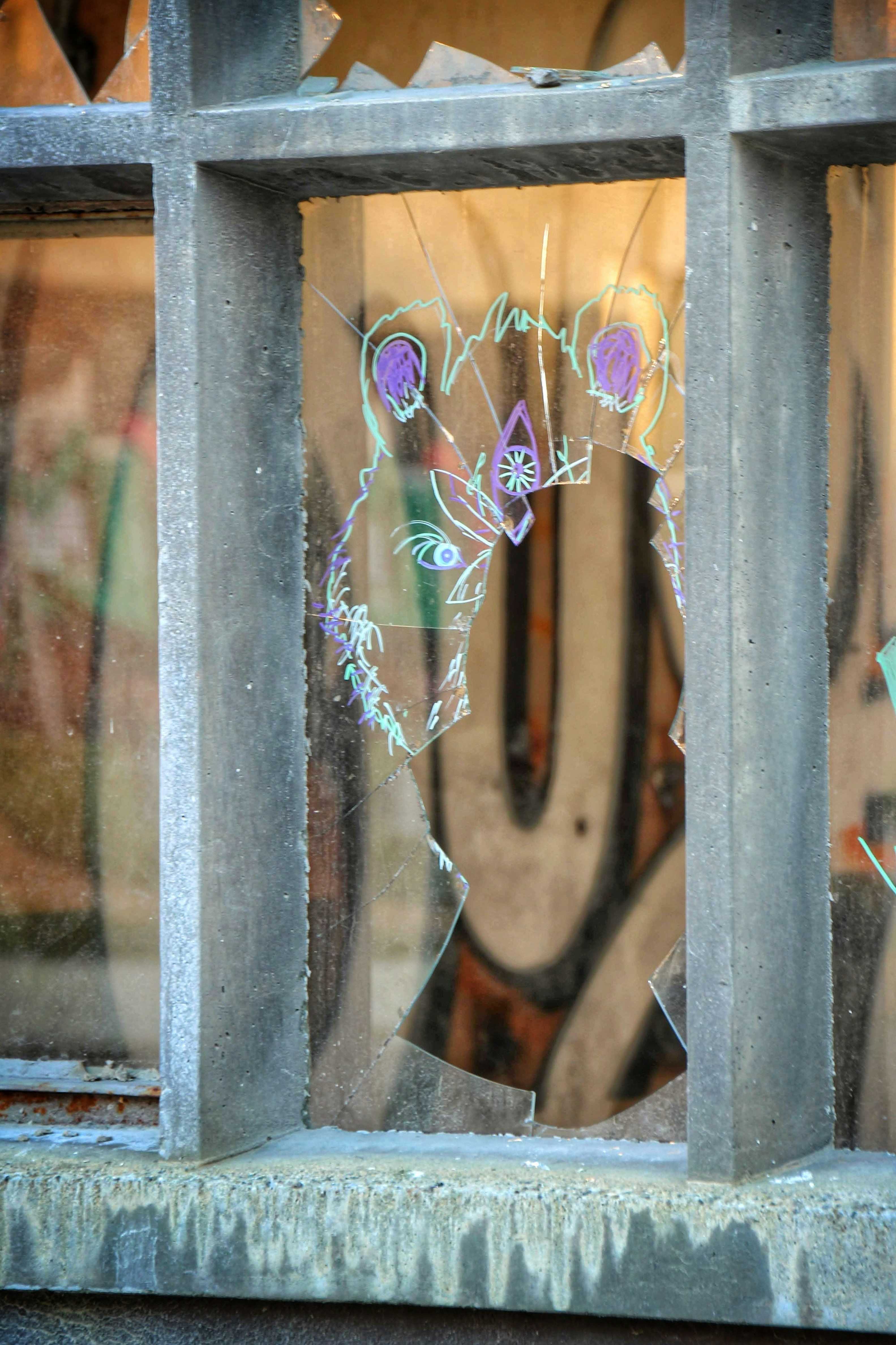 A broken glass window with graffiti on it photo – Free Attisholz Image ...