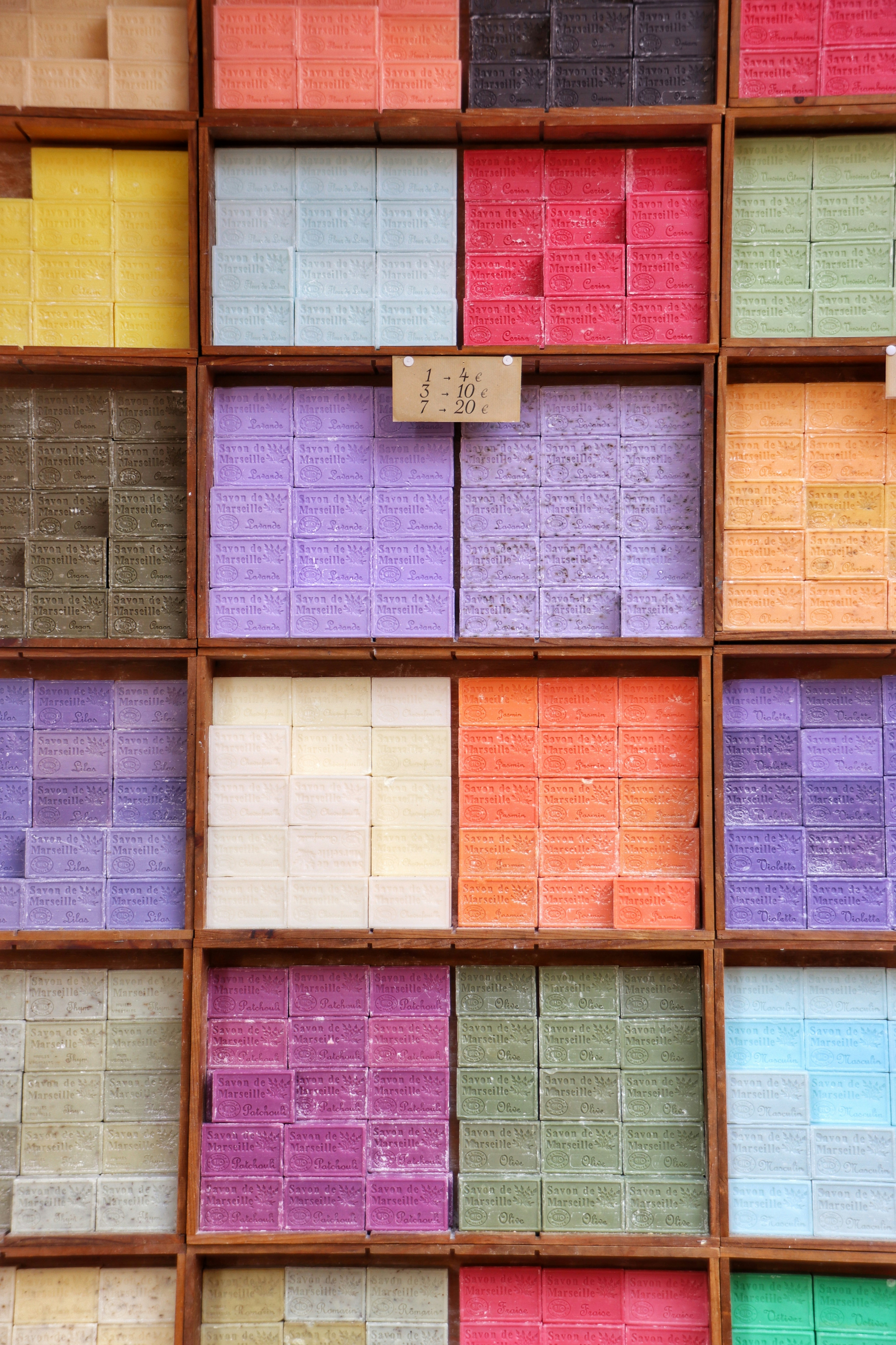 A multicolored display of wooden boxes filled with papers photo – Free ...