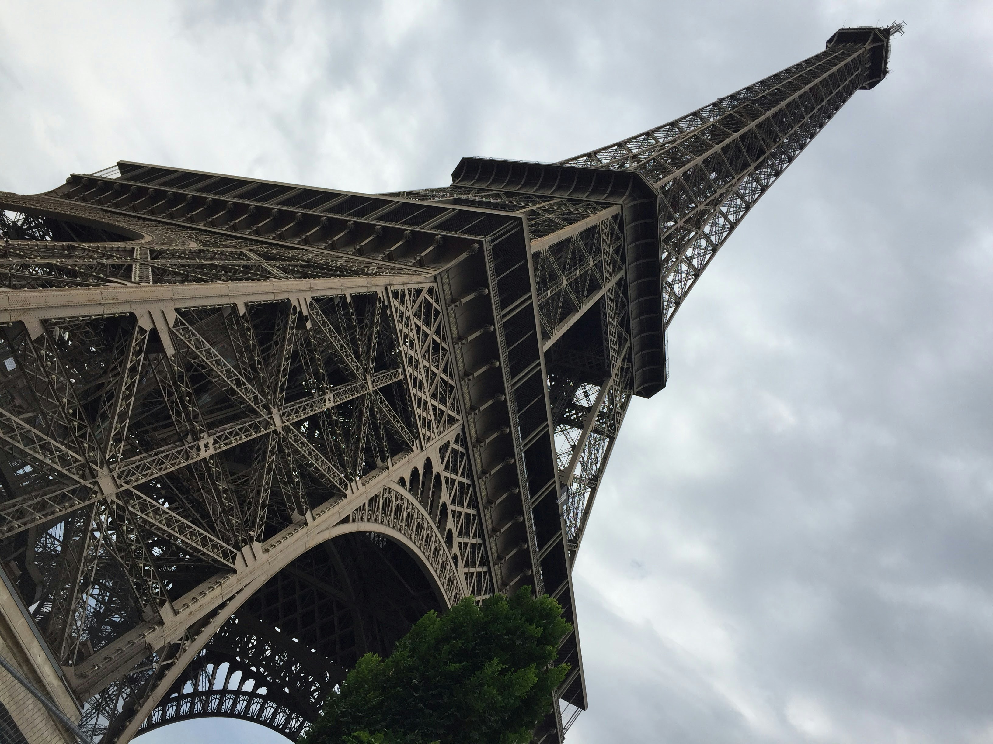 Ground-Up Iron Lace: The Eiffel Tower Ascends from a Cloudy Sky