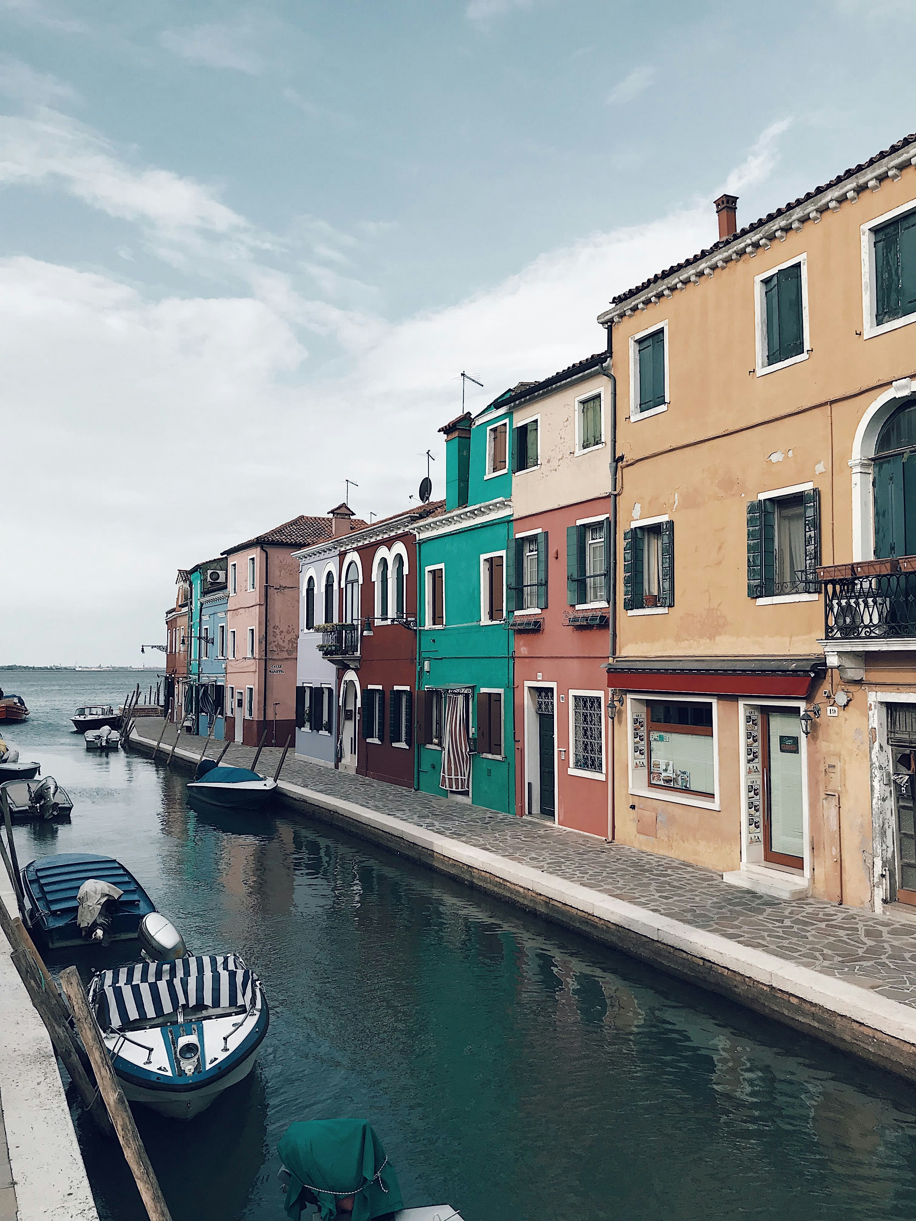 Sunlit Burano Row: Colorful Facades Reflect Along a Quiet Canal
