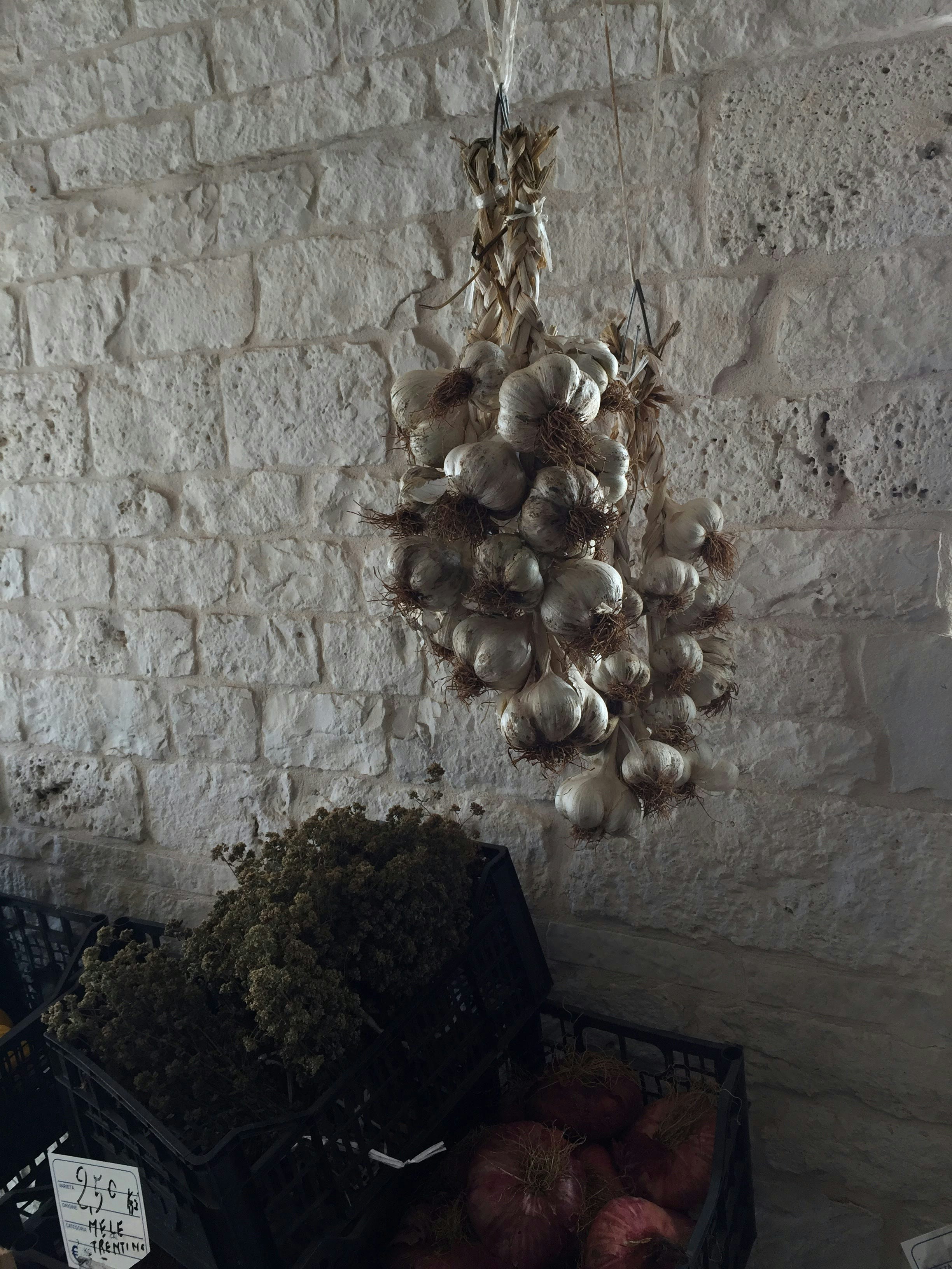 Hanging Garlic Bouquet Above Rustic Market Crates