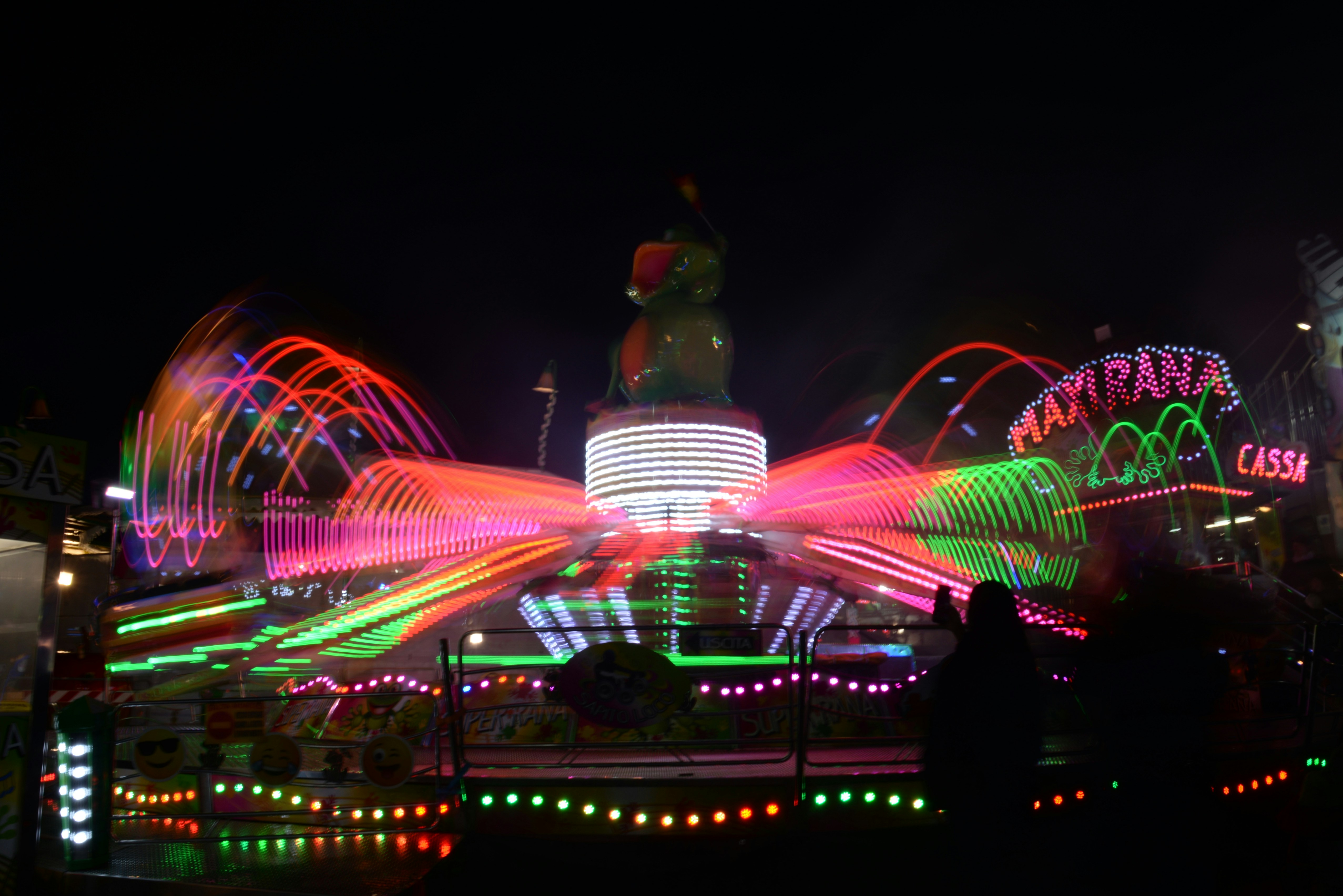A merry go round ride lit up at night photo – Free Urban Image on Unsplash