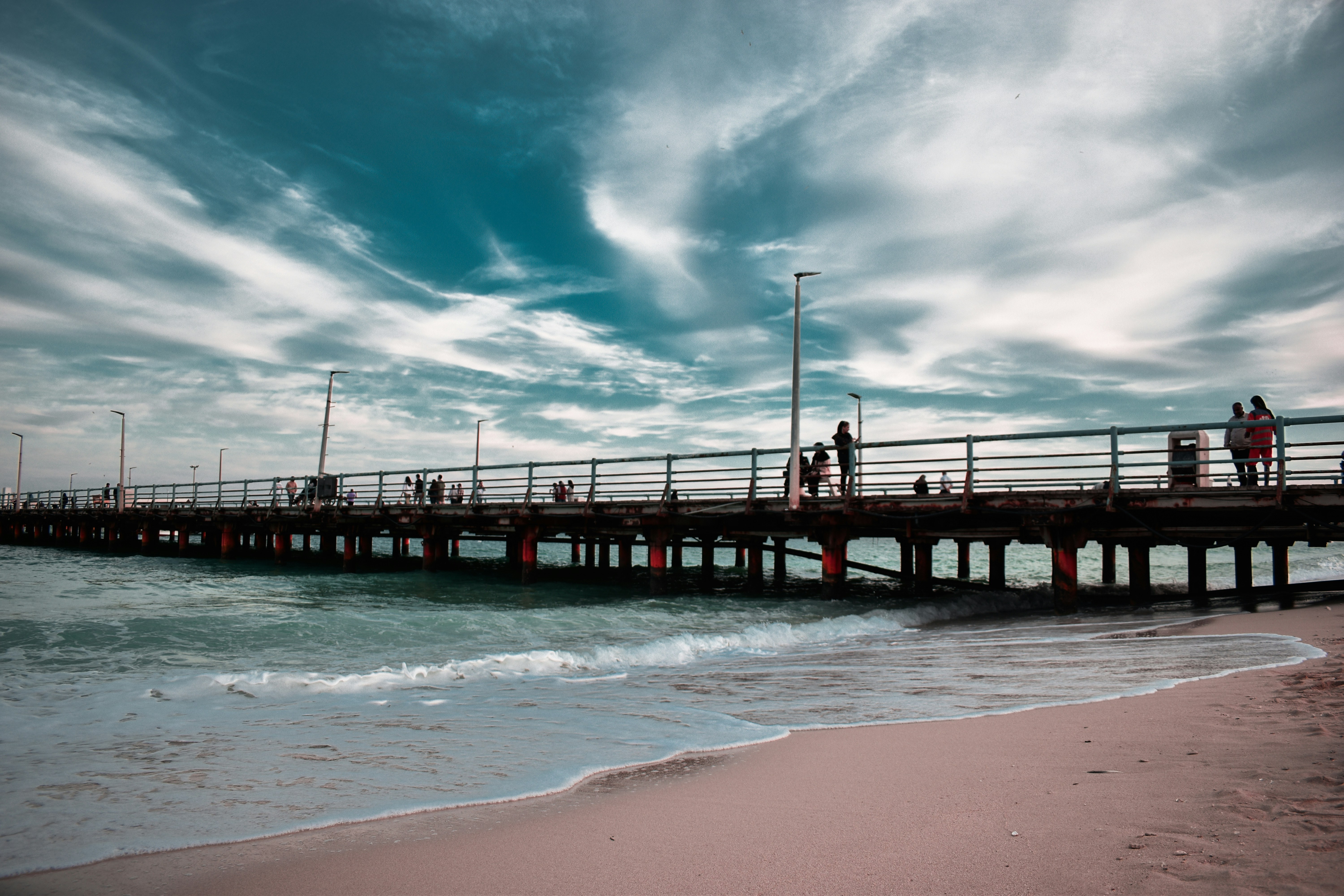 A pier on a beach with people standing on it photo – Free Kish island ...