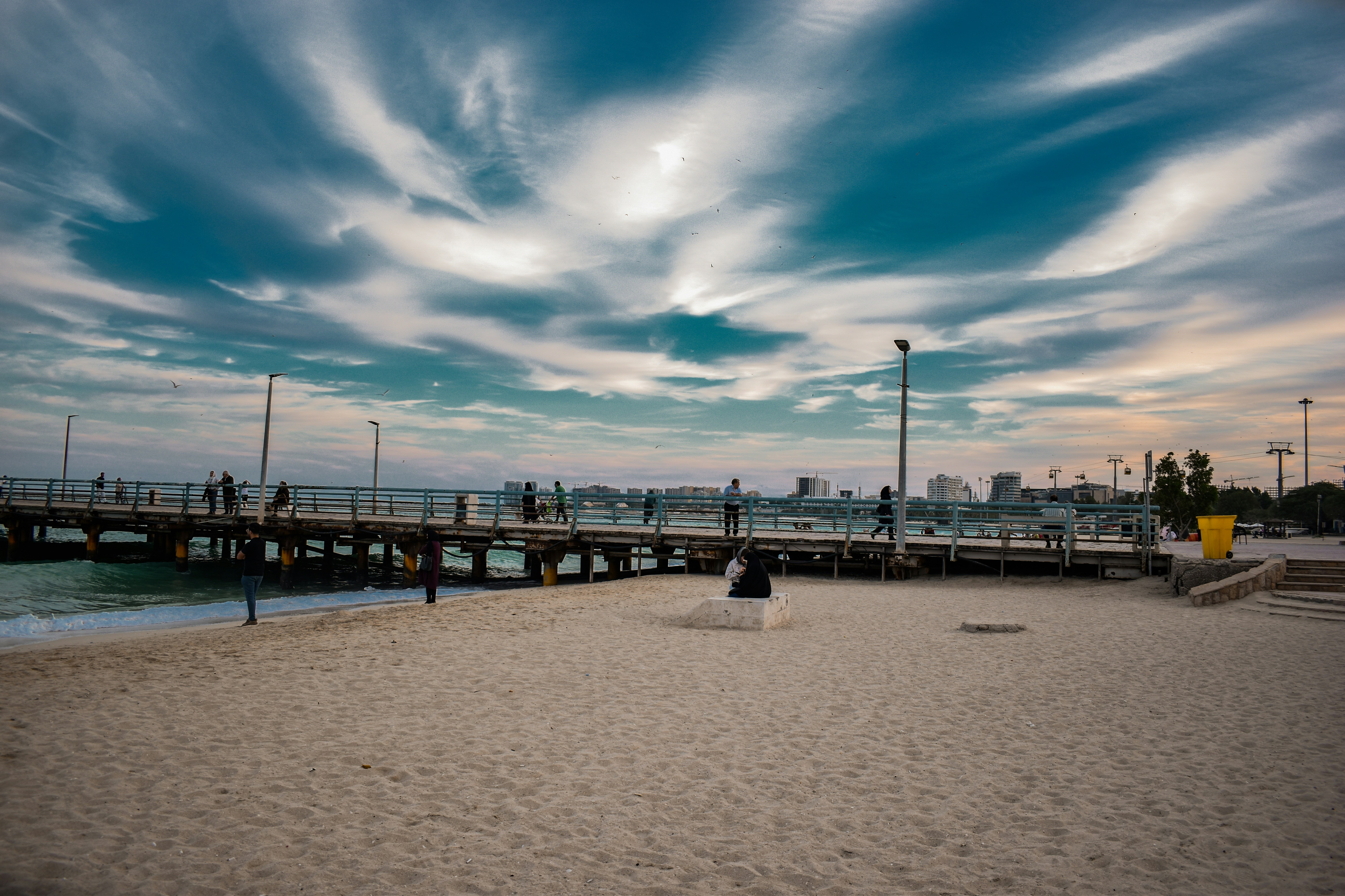 A sandy beach with a pier in the background photo – Free Kish island ...