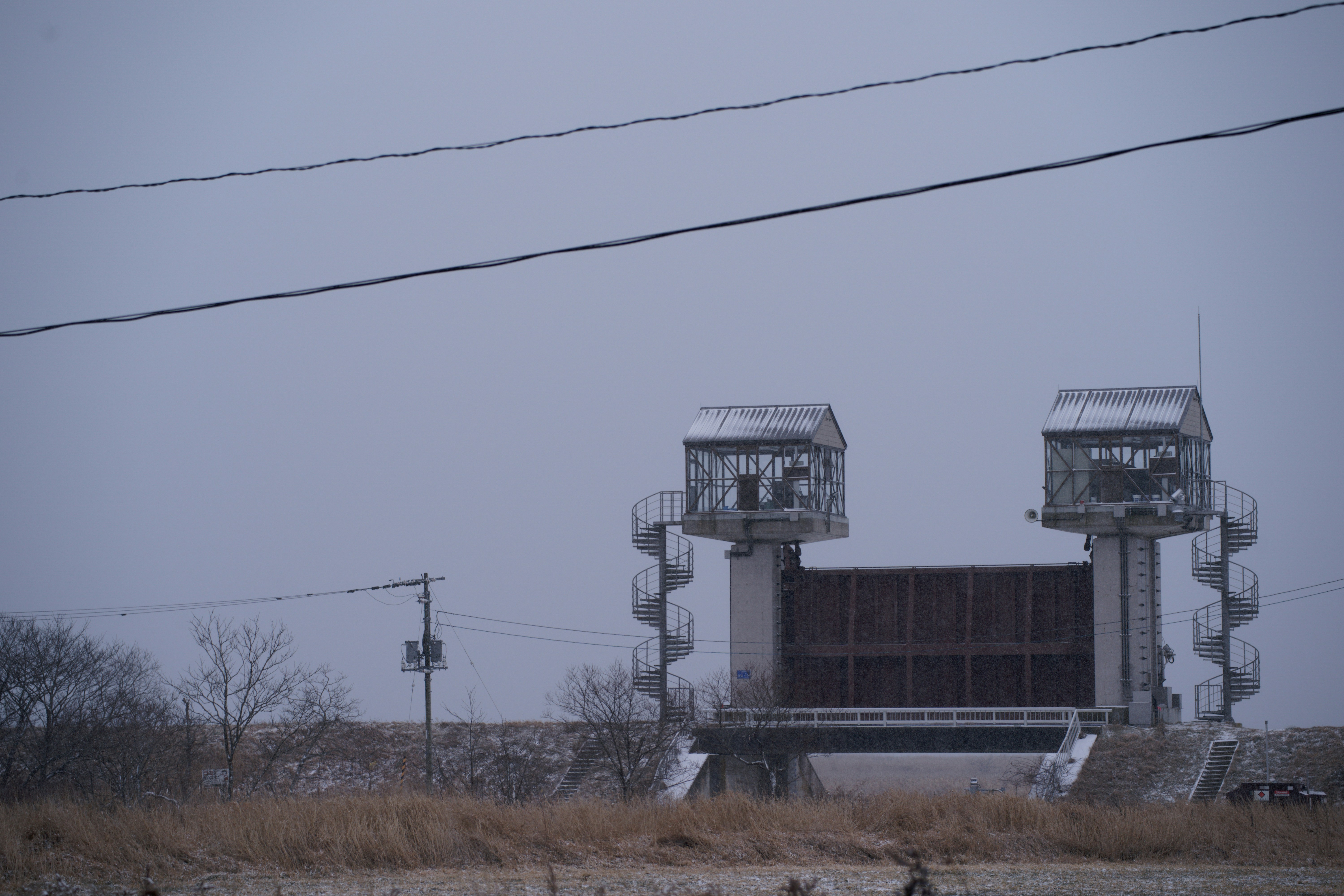 Twin Watch Towers Over a Weathered Gate in Winter