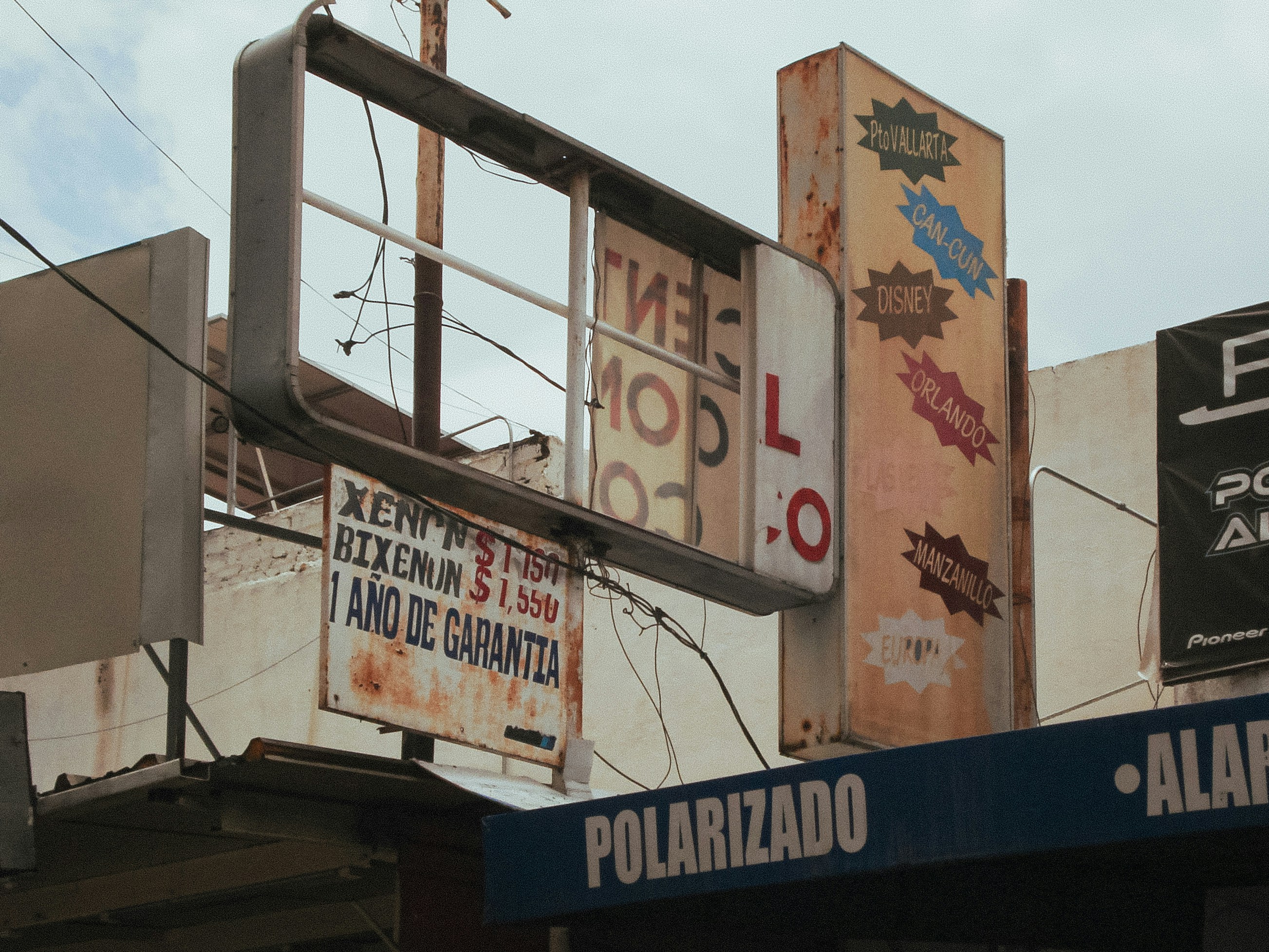 A bunch of signs that are on the side of a building photo – Free ...