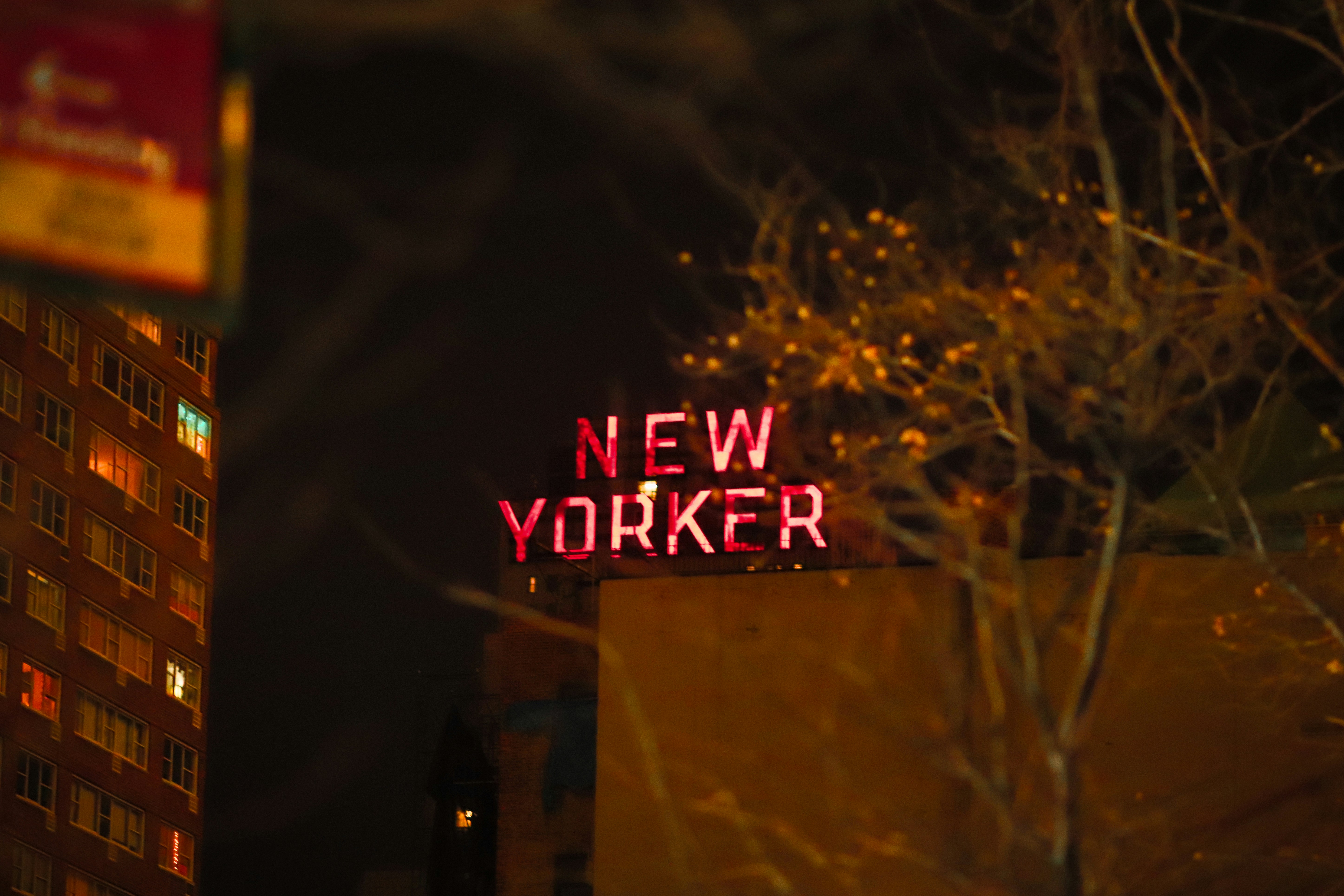 A neon sign that reads new yorker on the side of a building