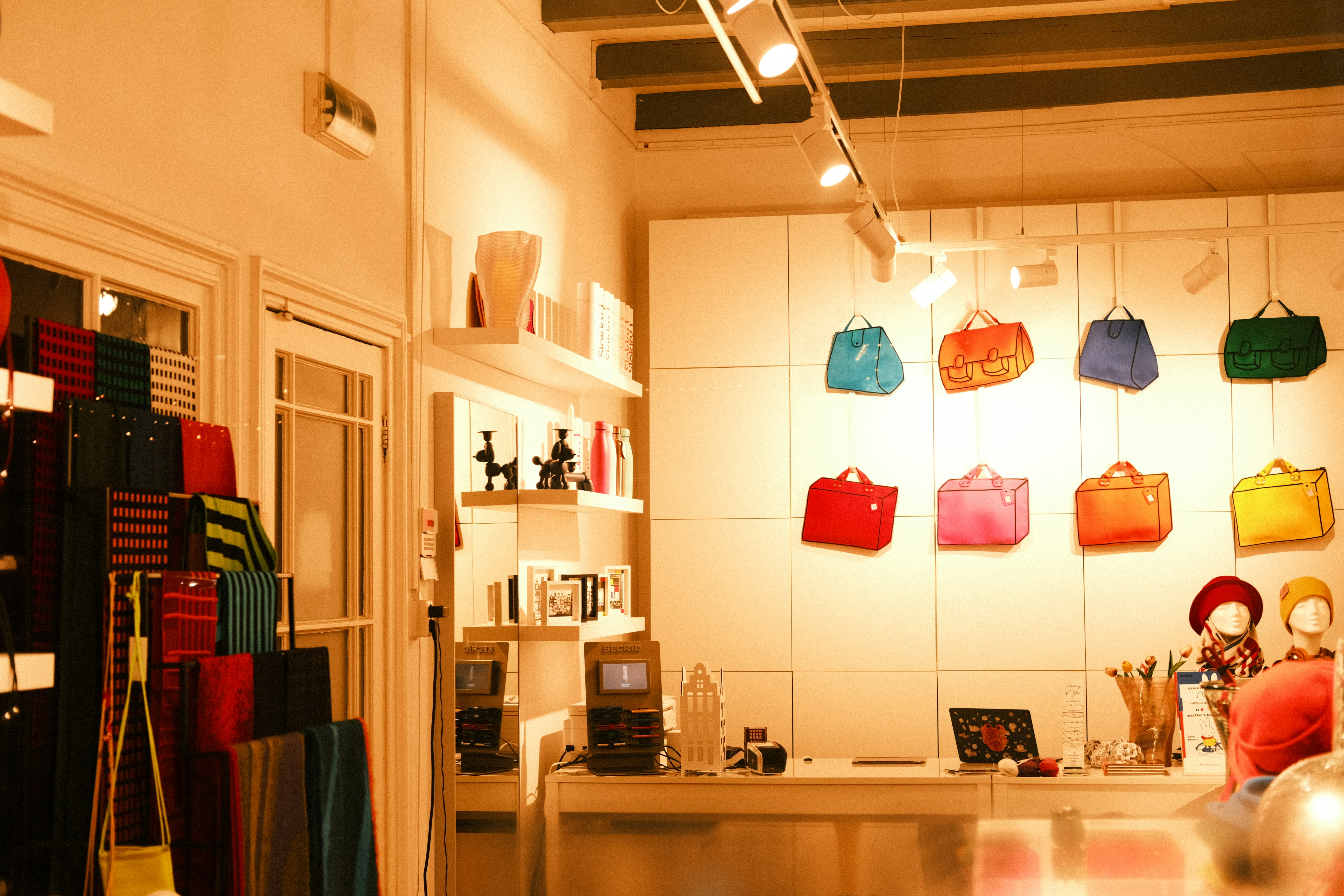 A room filled with lots of different colored bags photo – Free ...