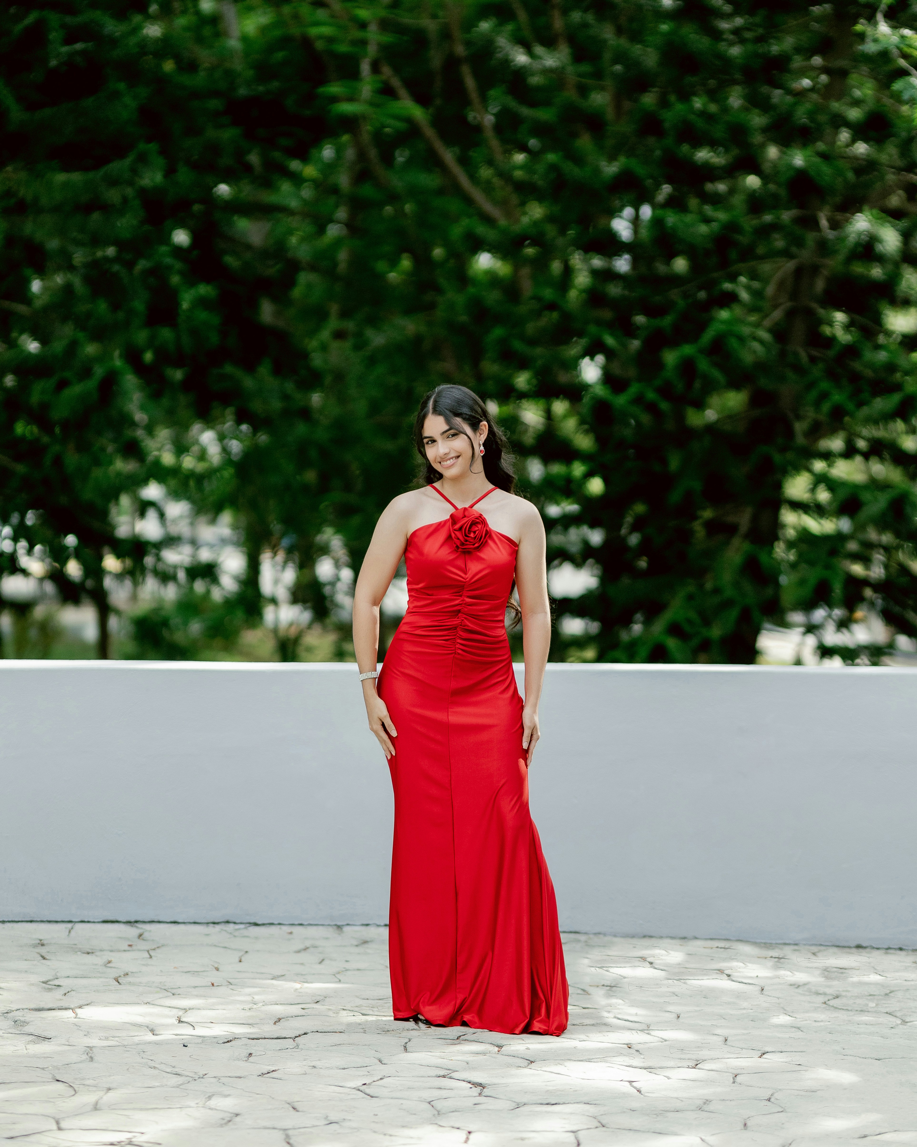A woman in a red dress posing for a picture photo – Free Woman Image on ...