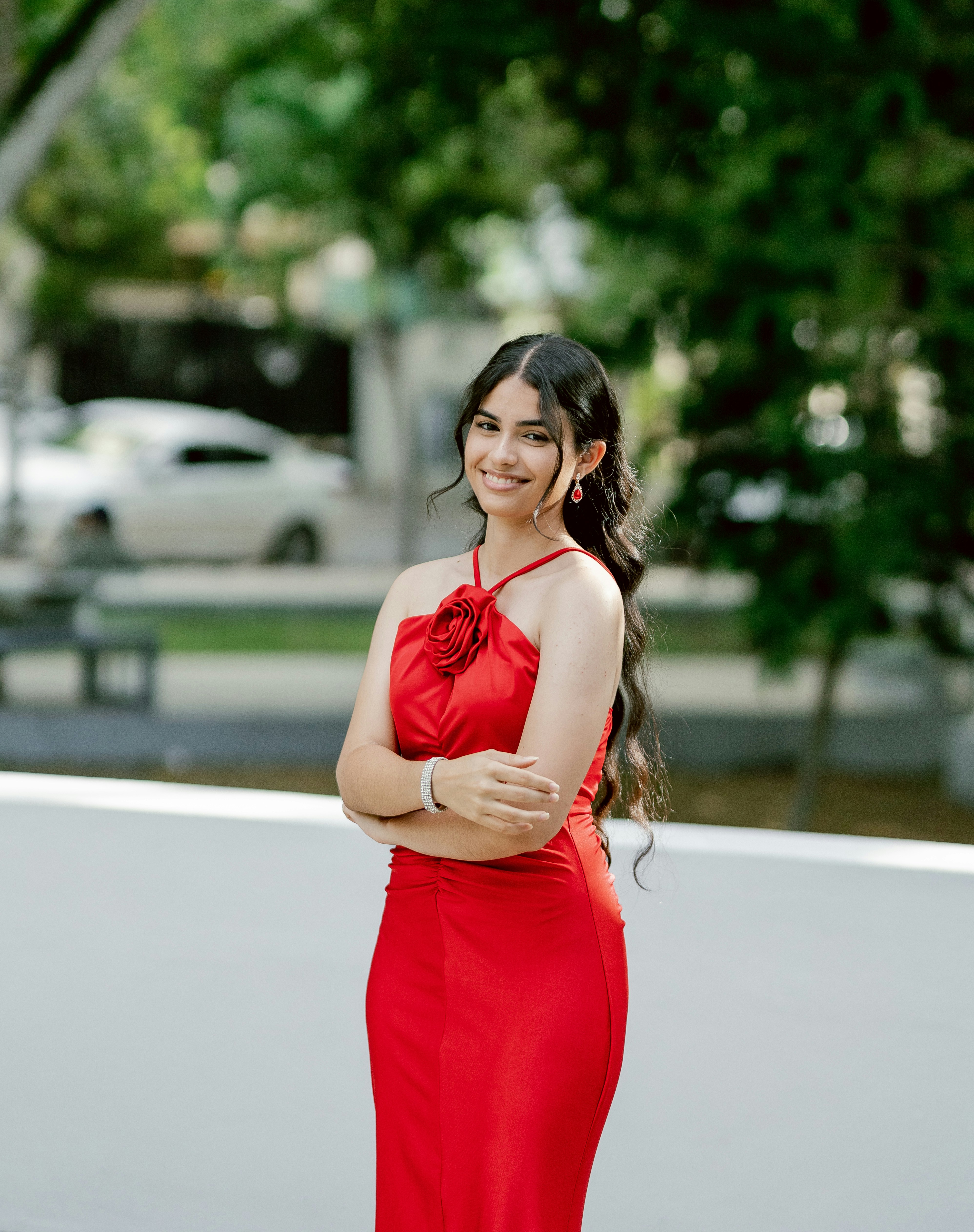 A woman in a red dress posing for a picture photo – Free Woman Image on ...