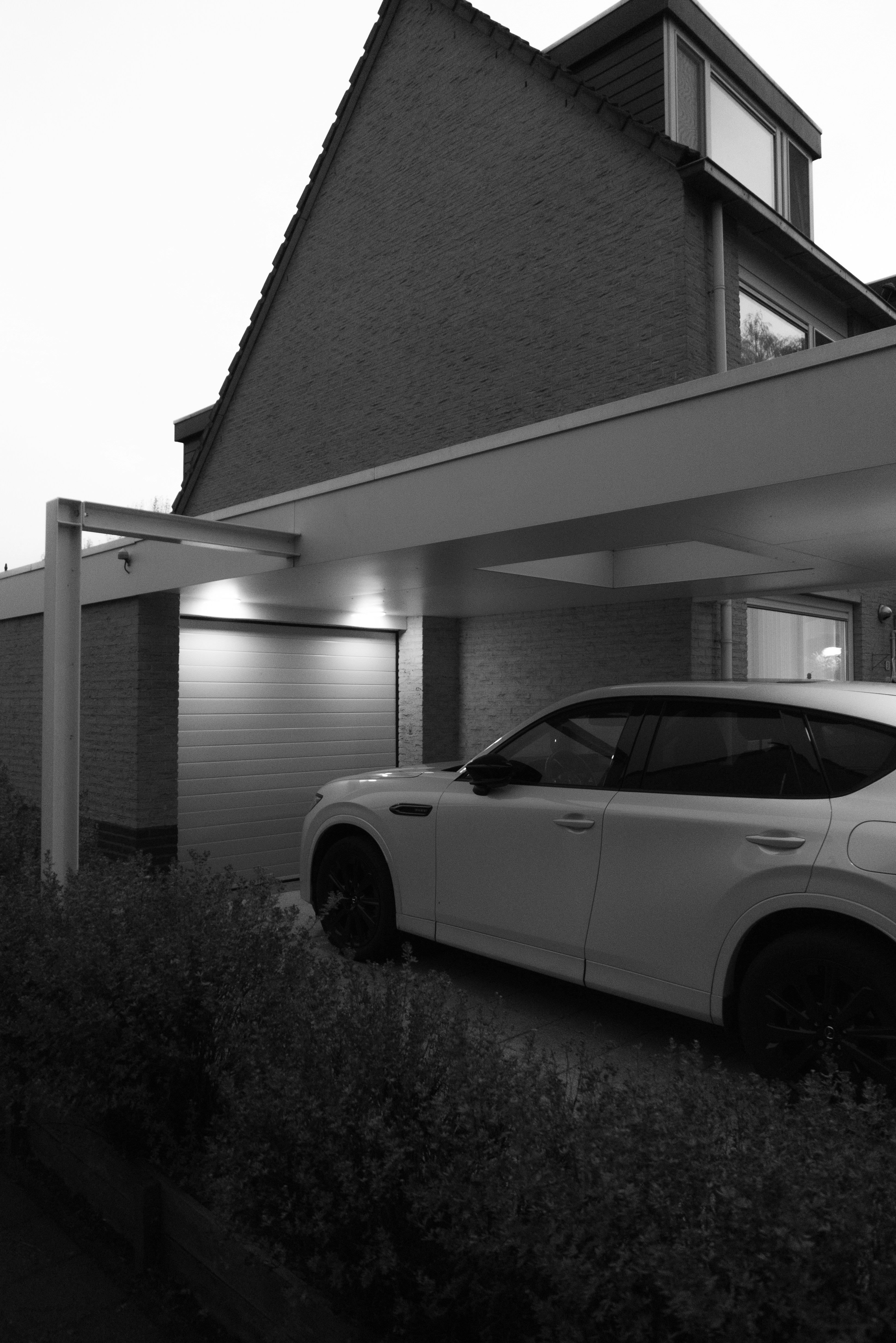 A white car parked in front of a house