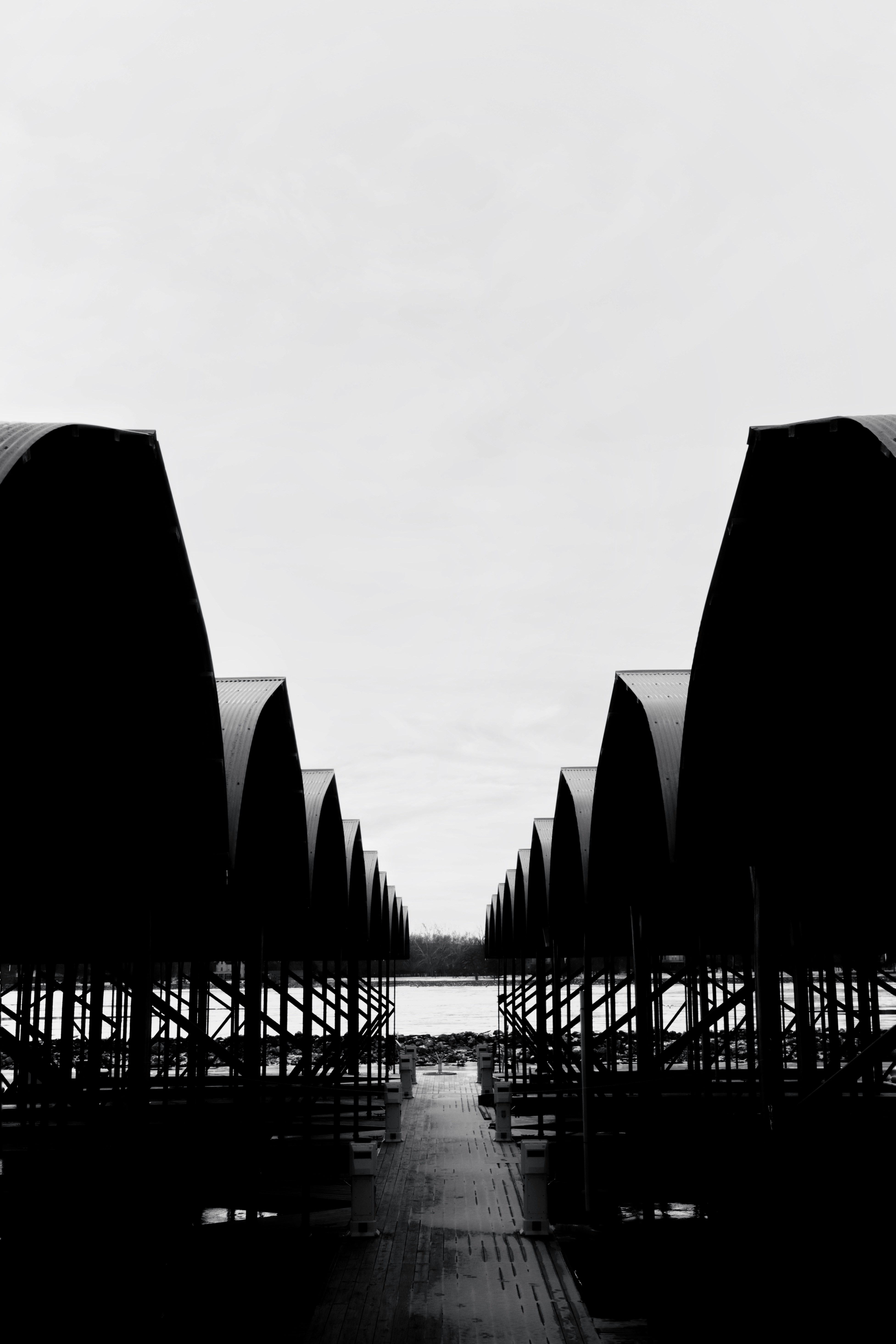 Monochrome Arcades: A Vanishing Pier Toward the Quiet Horizon
