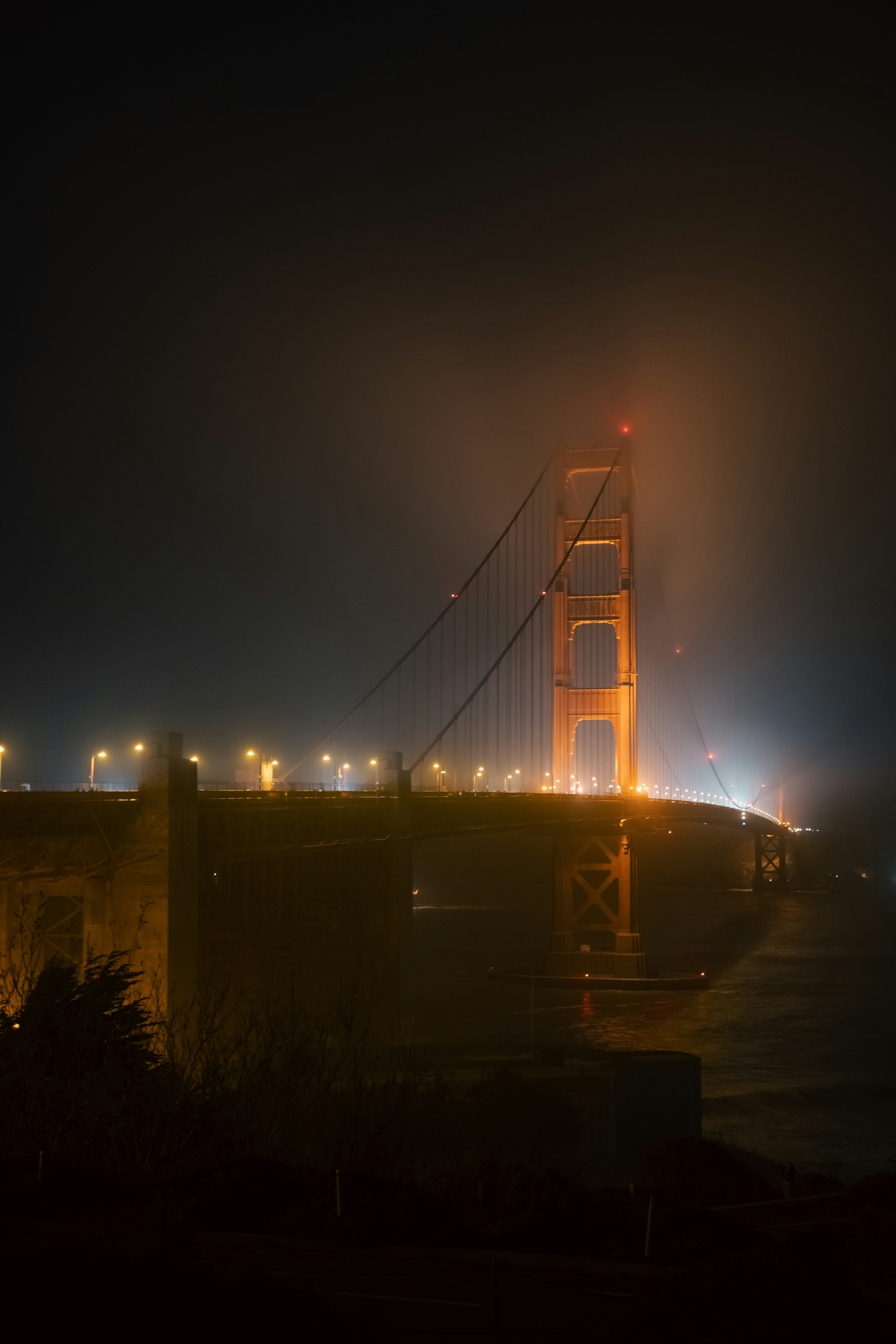 The golden gate bridge is lit up at night photo – Free Bridge Image on ...