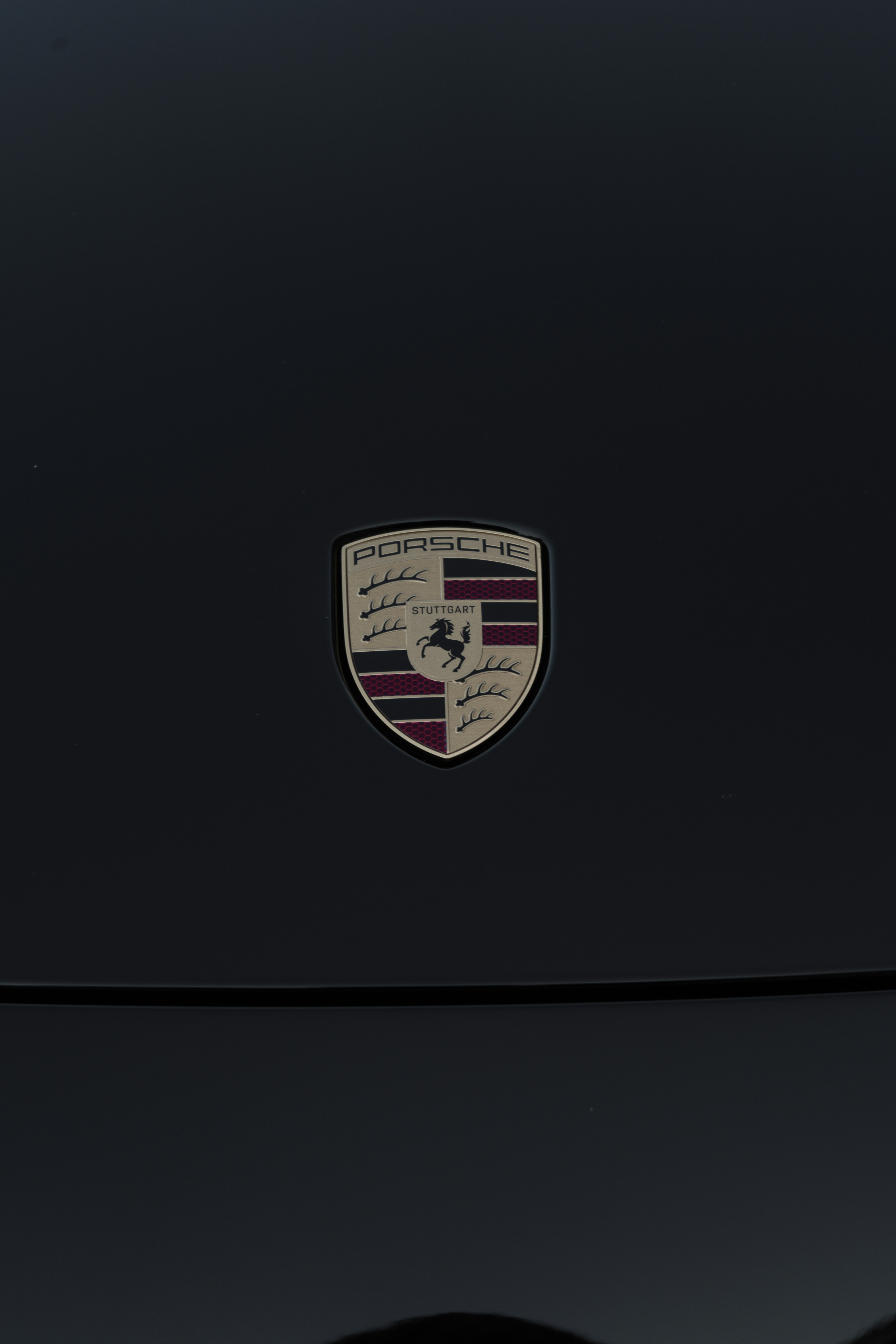 Midnight Matte Hood Cradles a Porsche Crest