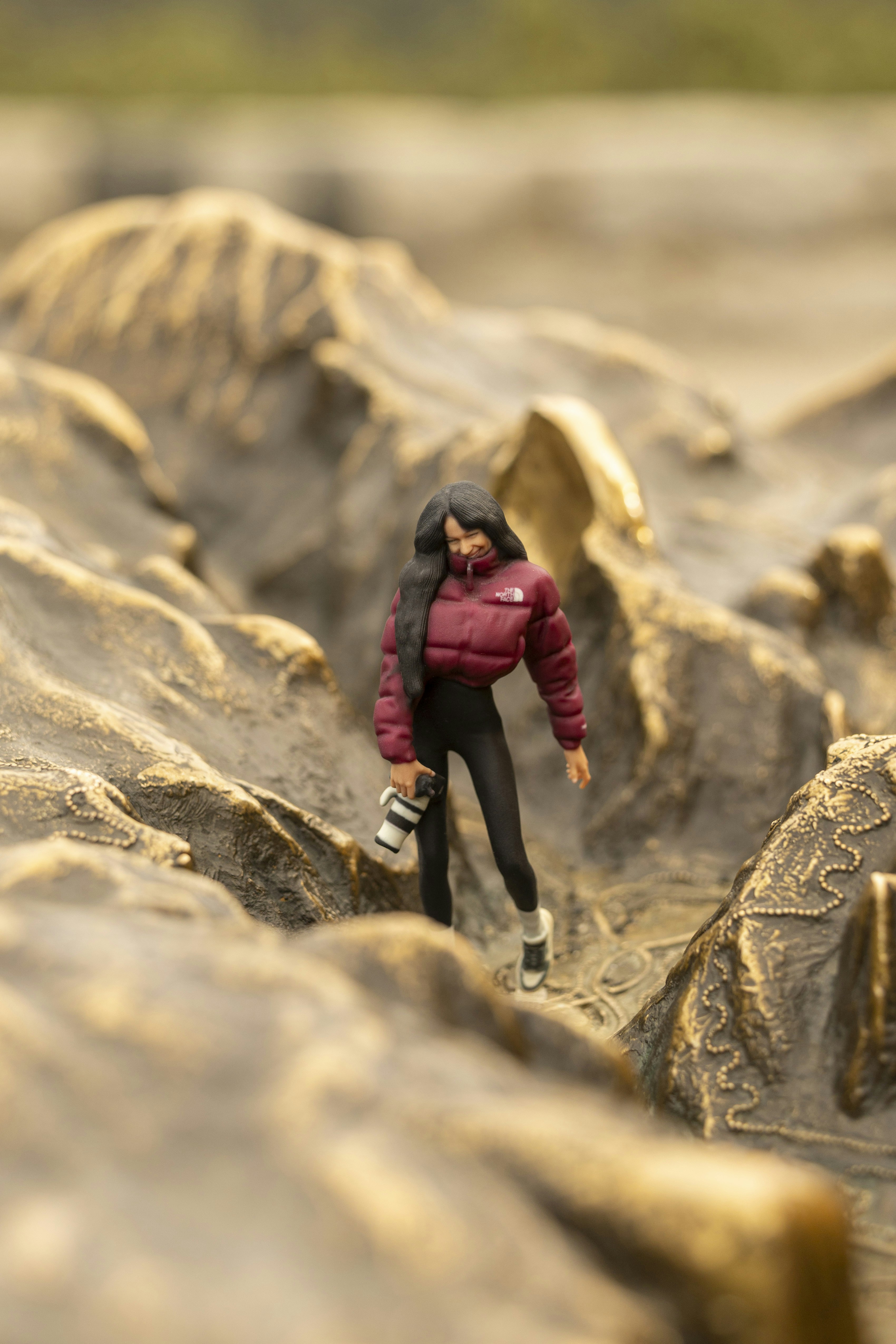 Miniature Explorer on Weathered Rocks with a Credible Lens in Hand