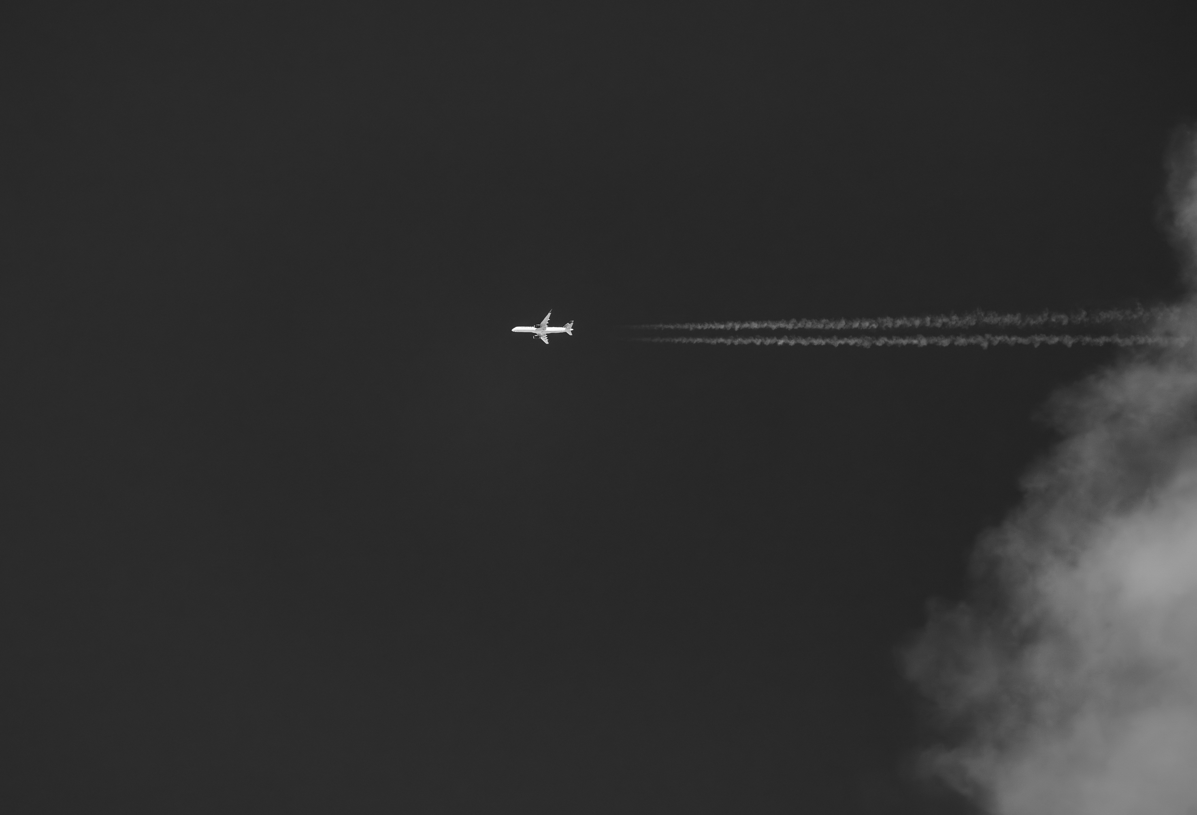 An airplane flying in the sky with smoke coming out of it photo – Free ...