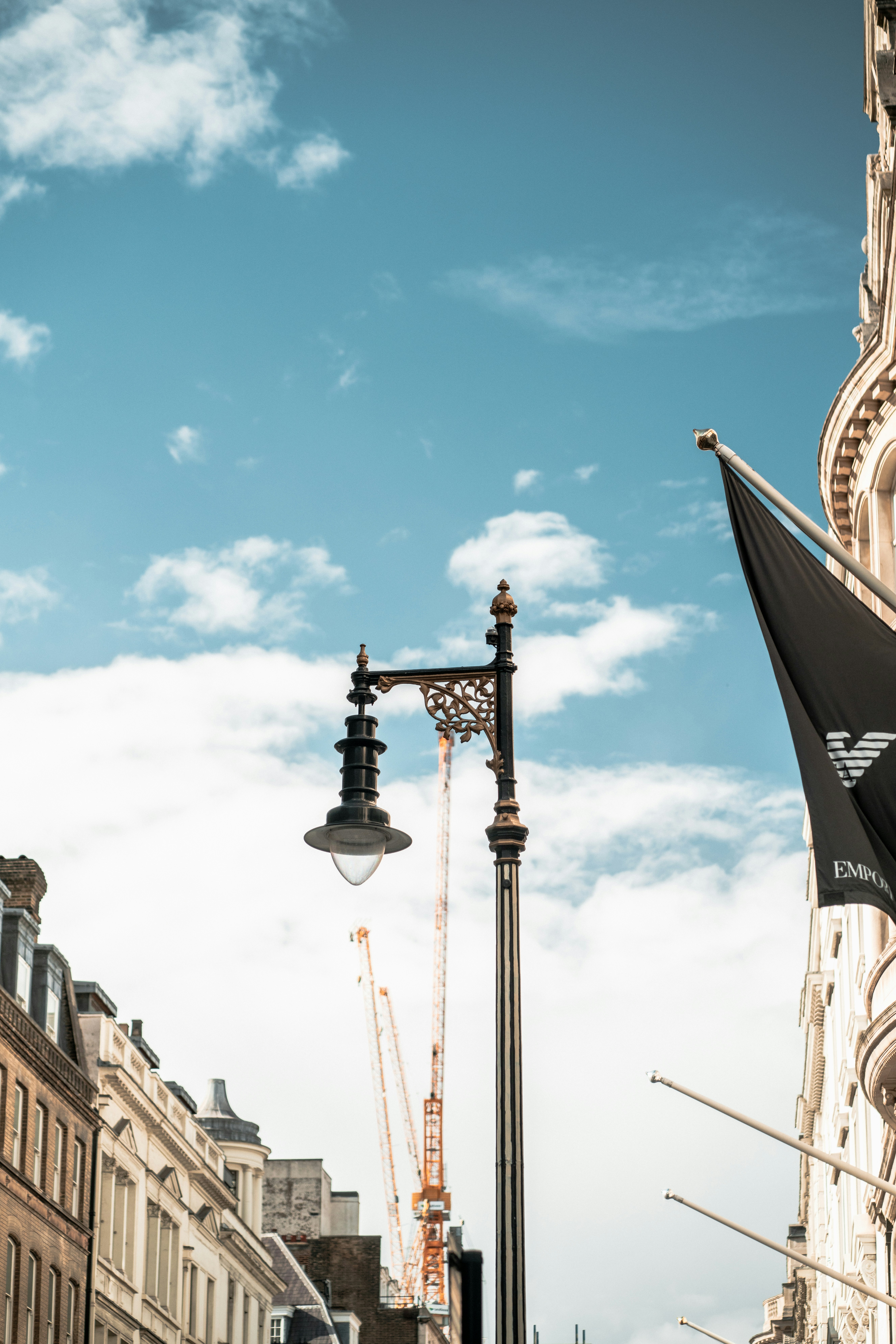 Urban scaffolding and flag meet the skyline