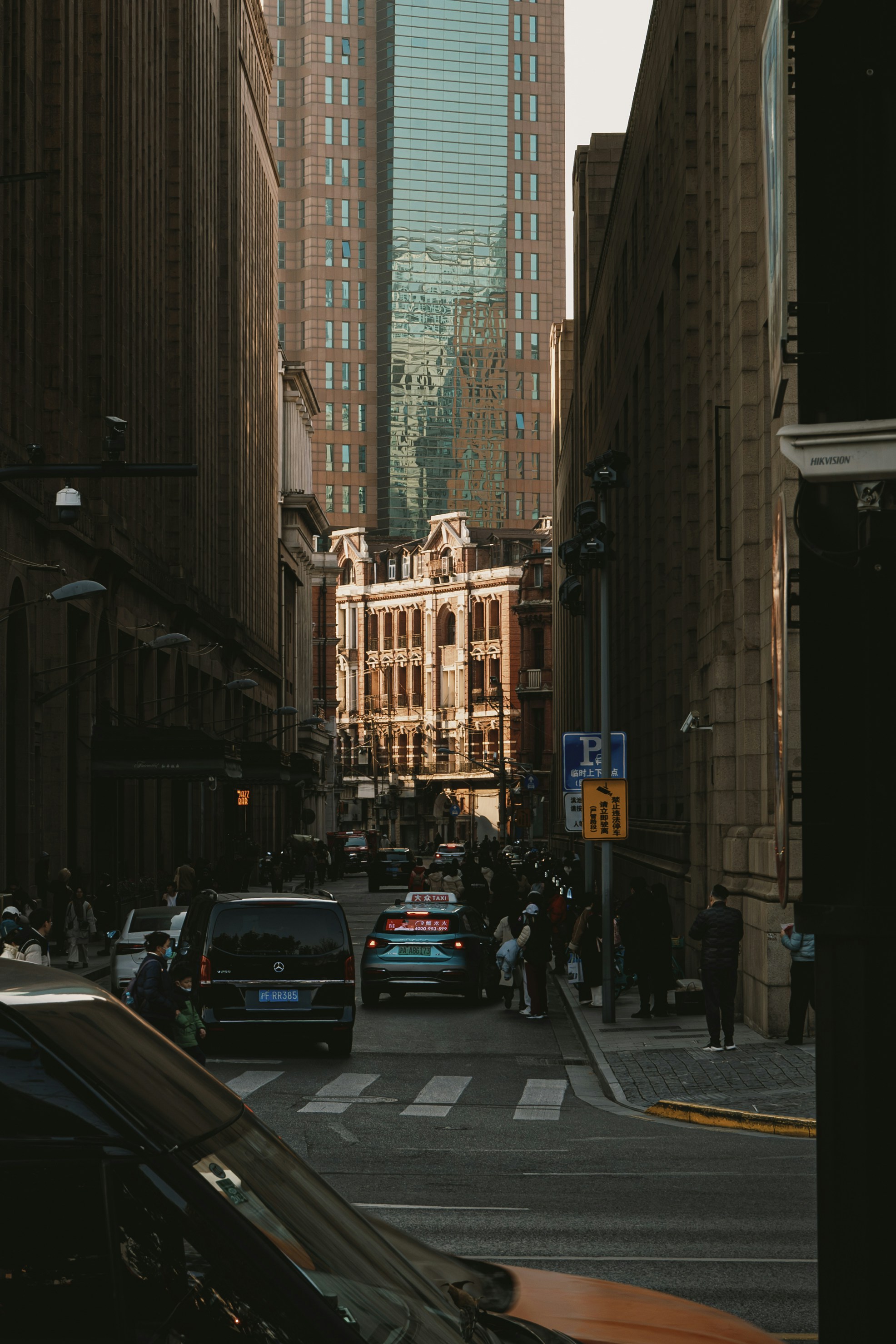 Sunlit Facade Between Glass Giants: A Downtown Street Portrait